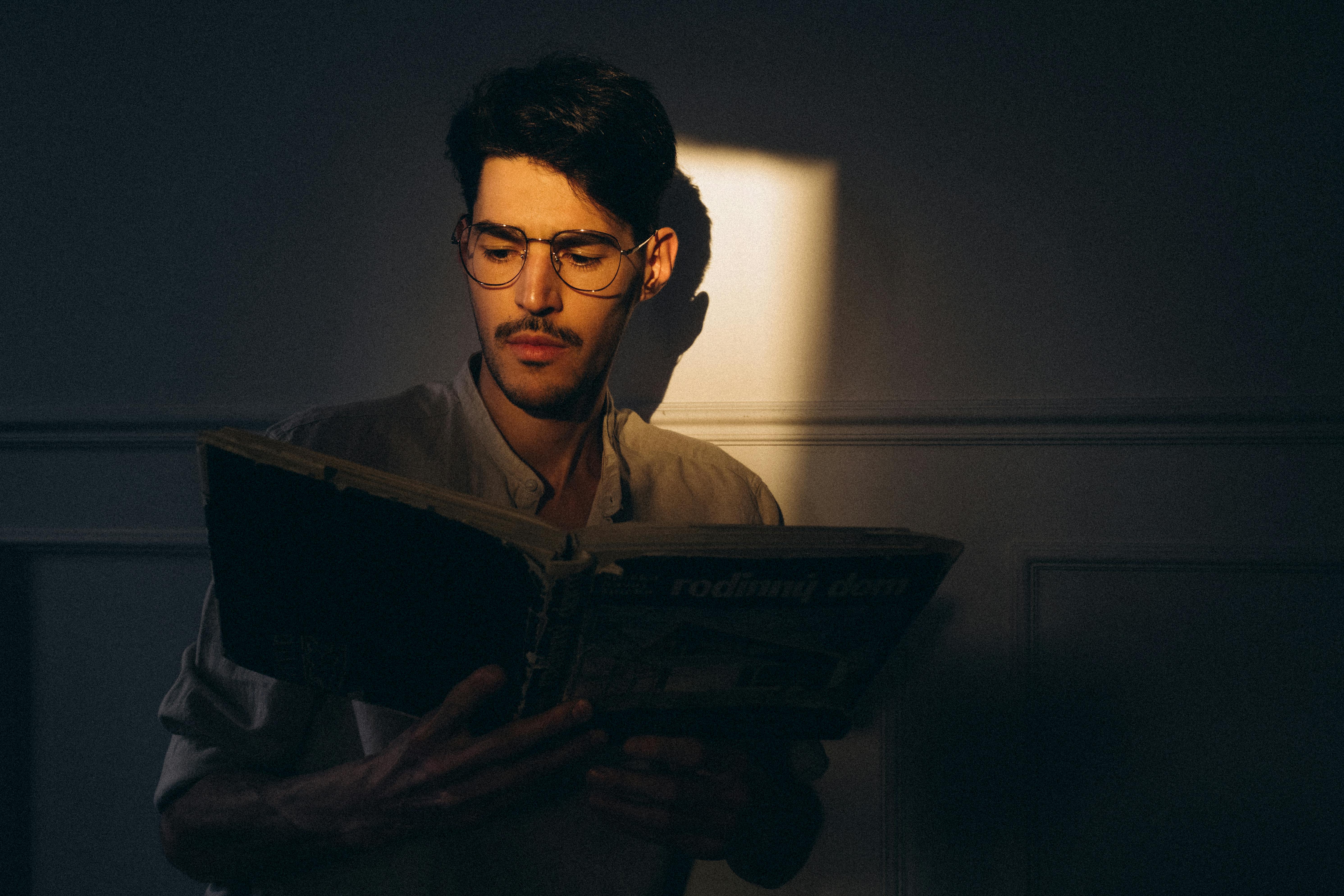 Portrait of man reading book · Free Stock Photo