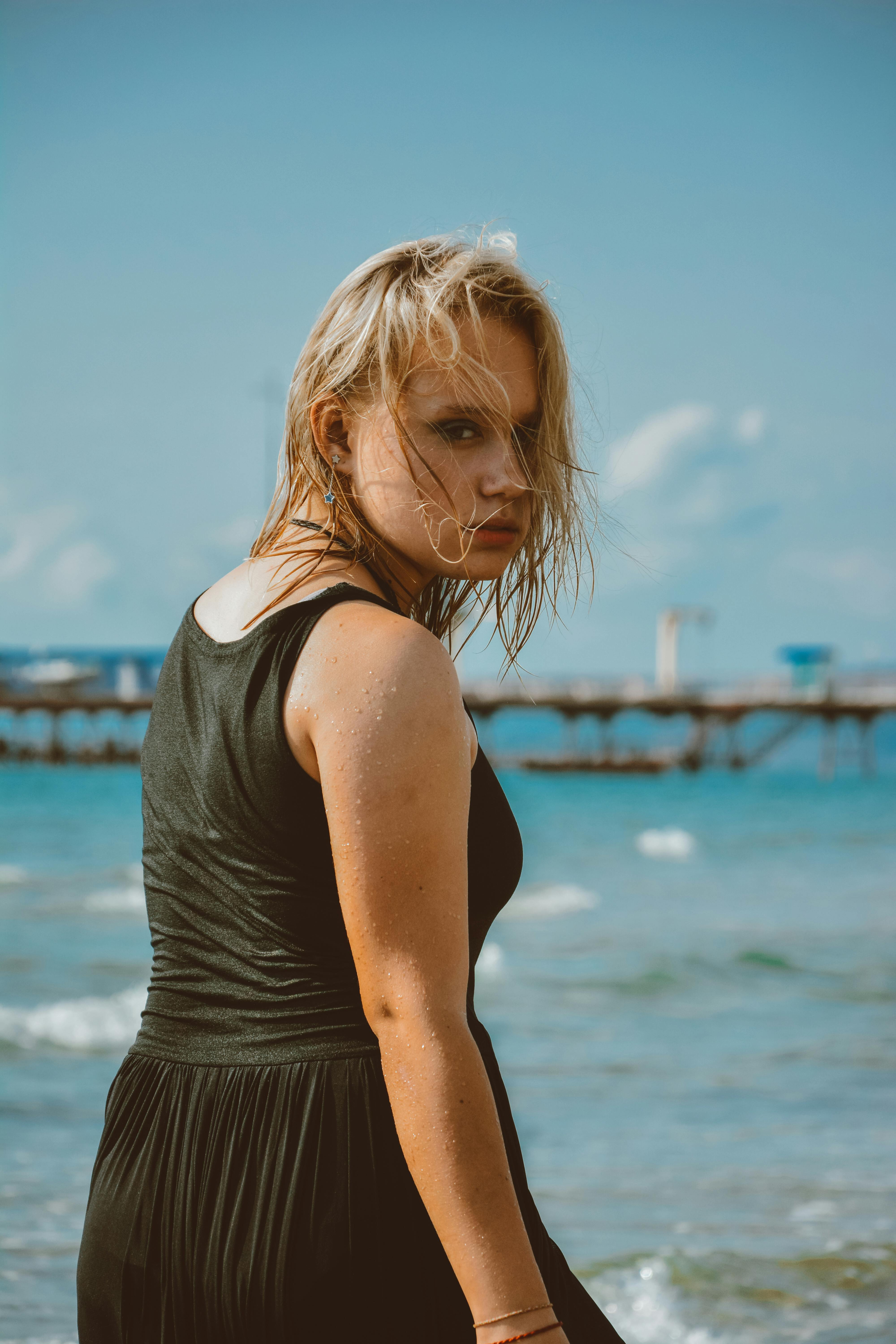 Wet Woman Lying on White Wooden Raft · Free Stock Photo