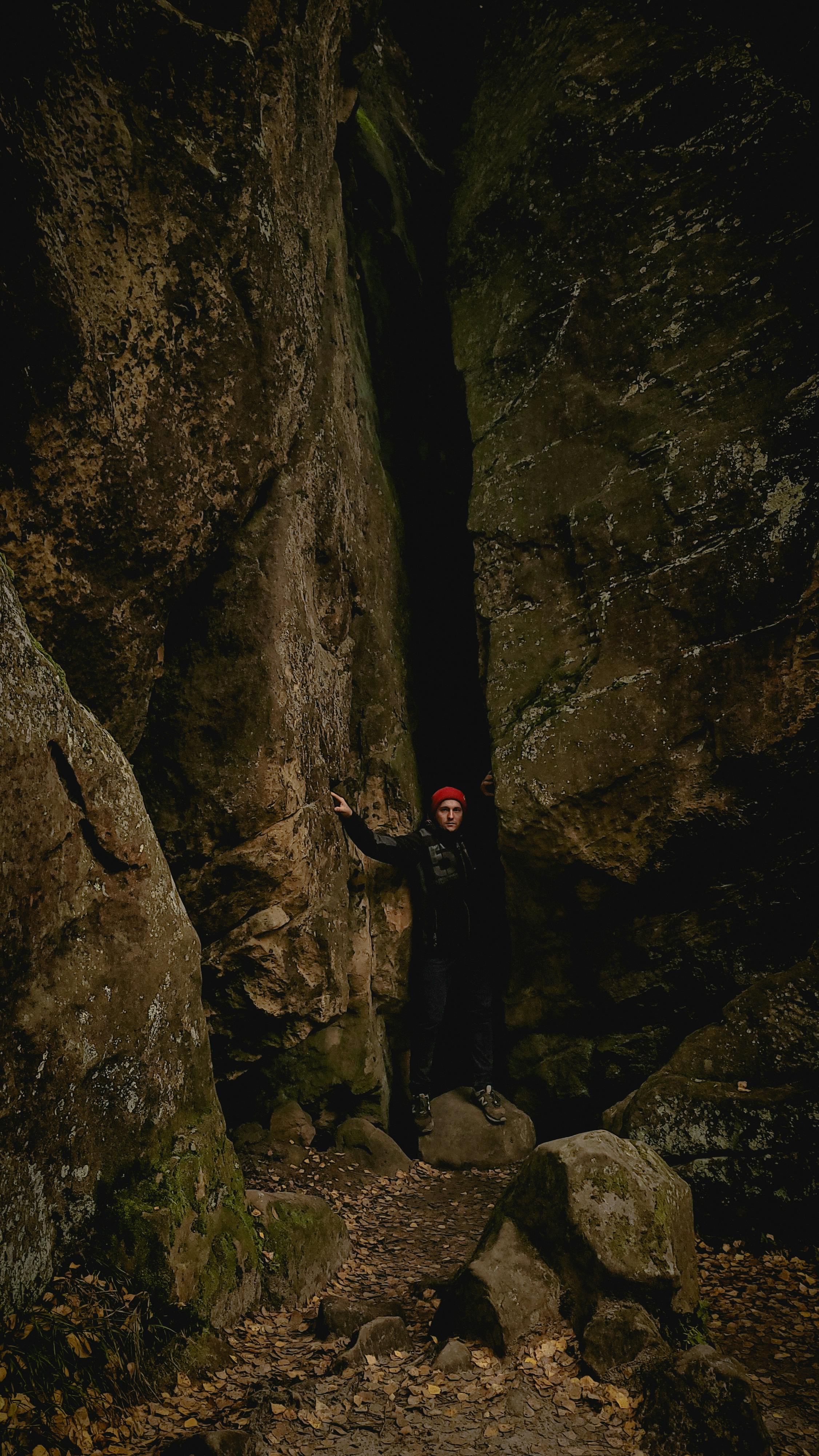 A Man in Between the Gap of Rocks Formation · Free Stock Photo
