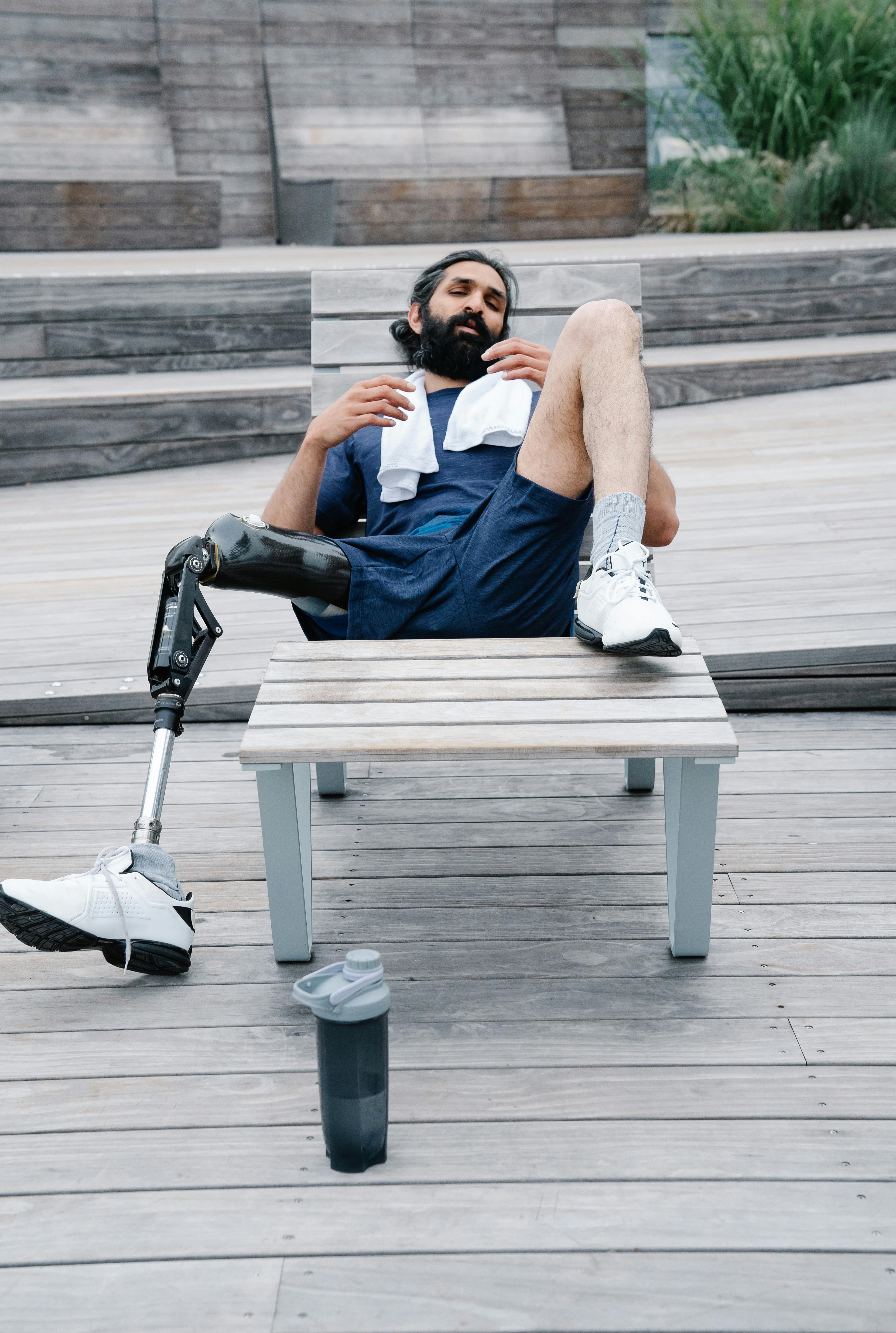 Man with Prosthetic Leg resting on Lounge Chairs · Free Stock Photo
