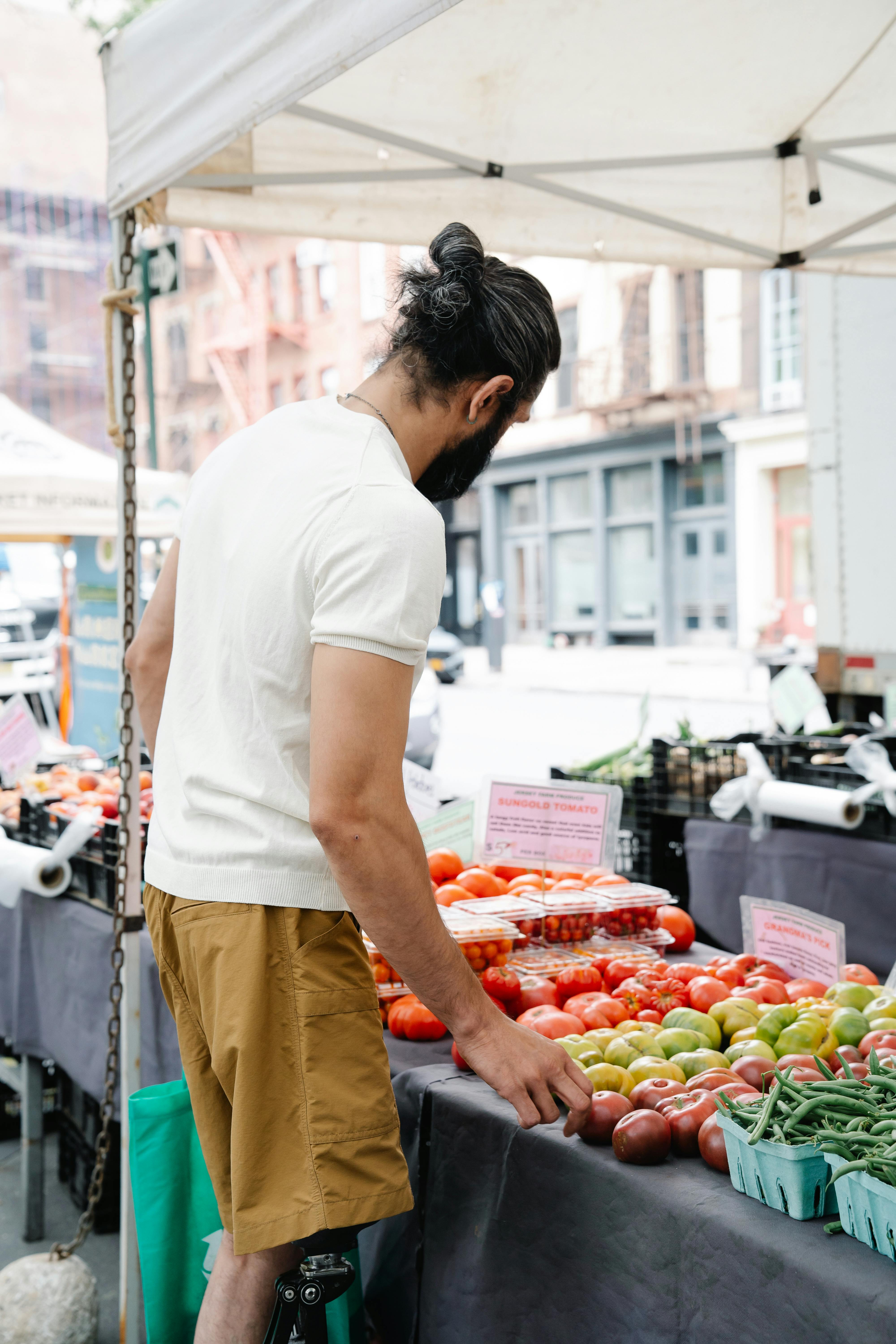 Man standing in front of Fruit Stand · Free Stock Photo