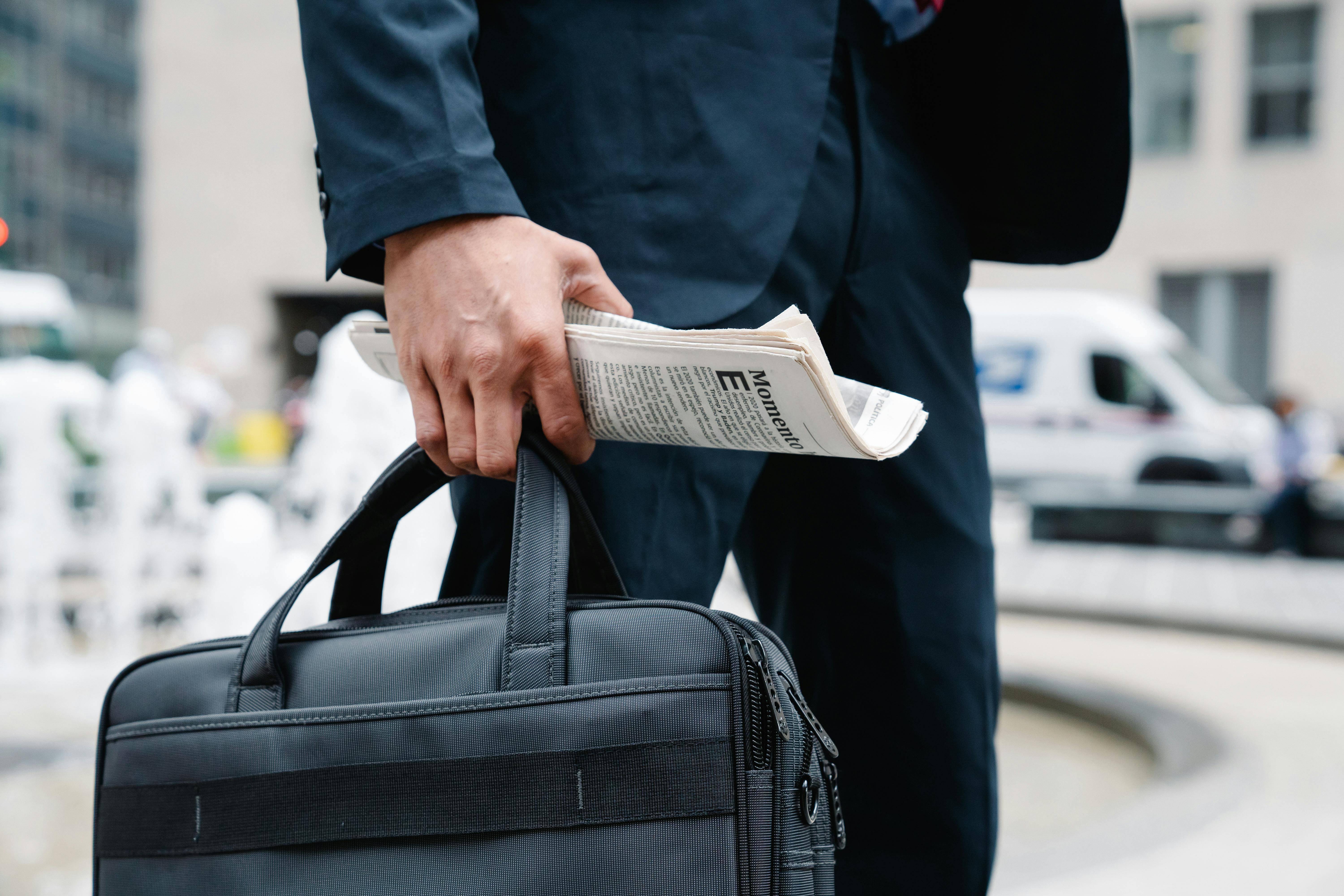 Close-up Photo of Person carrying Black Hand Bag and Newspaper · Free ...