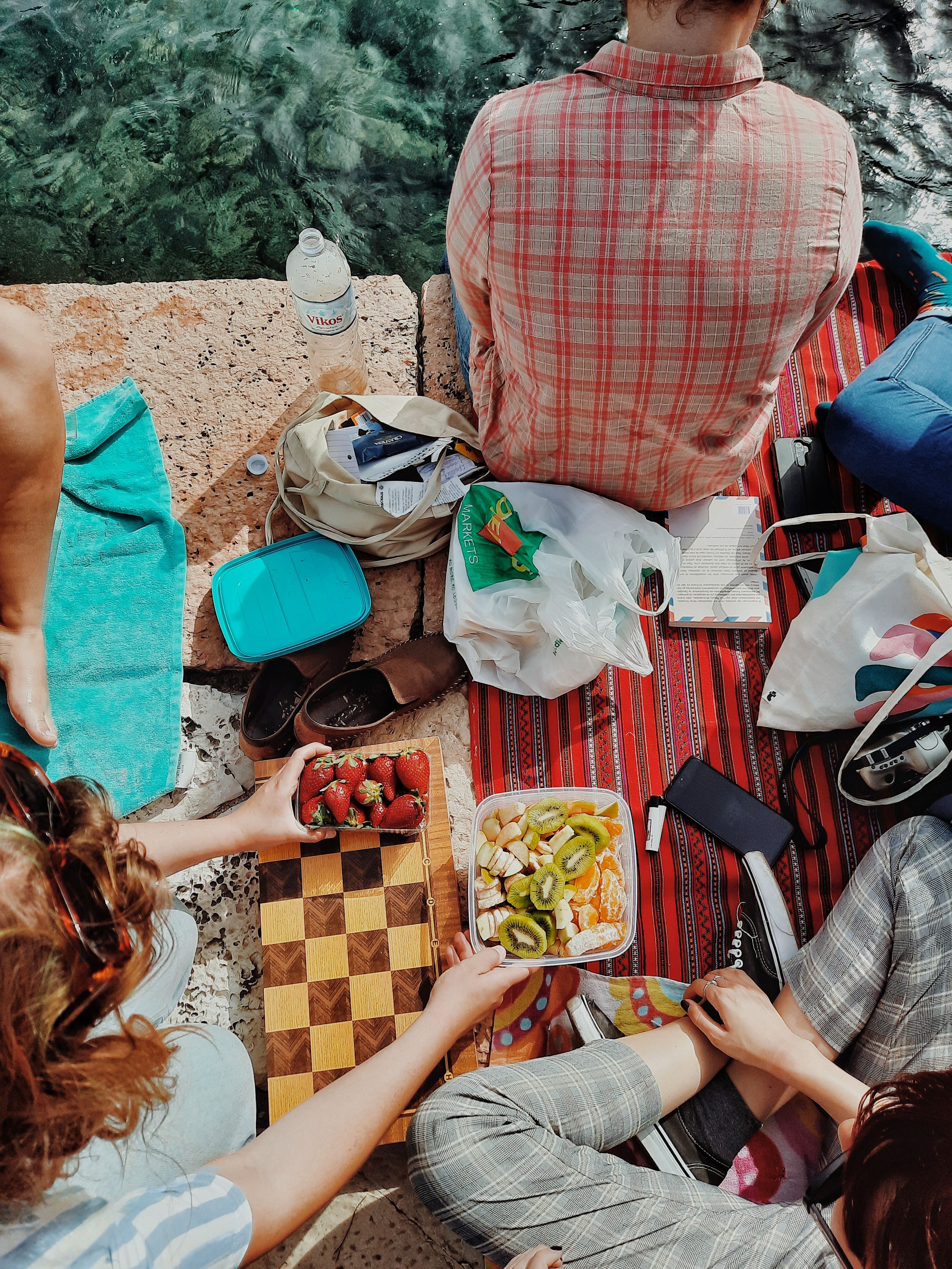 People Having a Picnic on a Ledge · Free Stock Photo