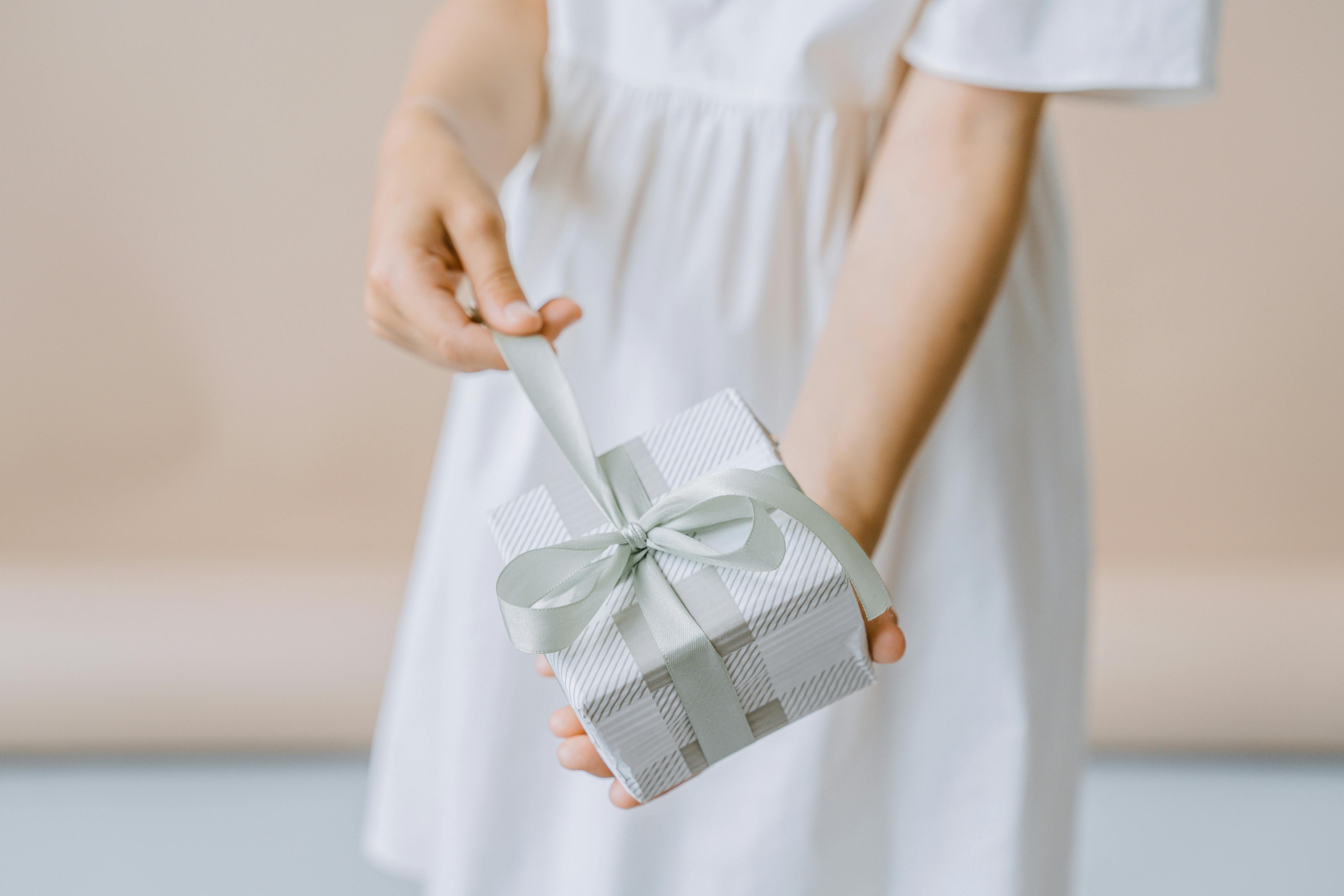 A Person Holding a Present · Free Stock Photo