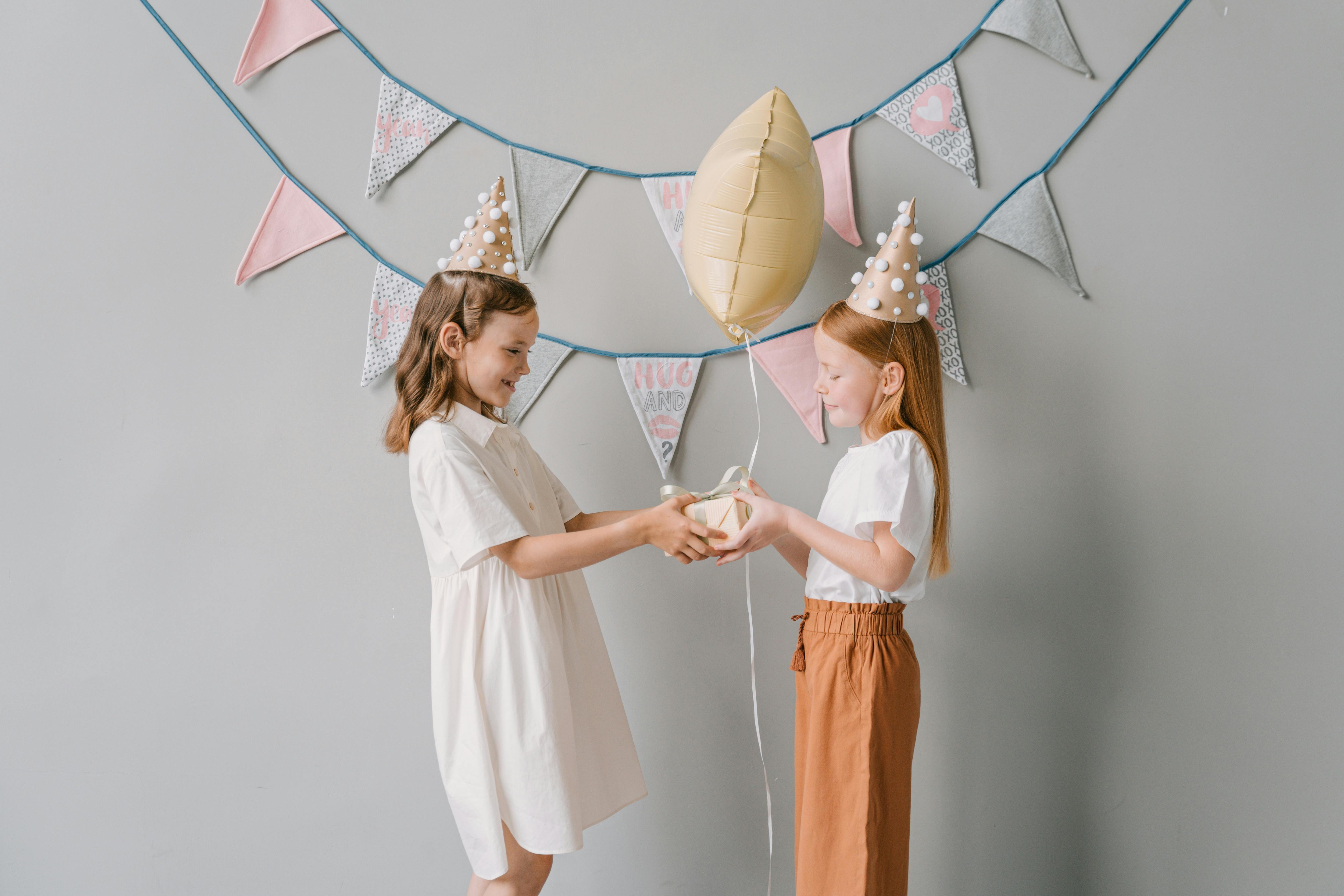 A Girl Giving a Gift to a Birthday Celebrant · Free Stock Photo