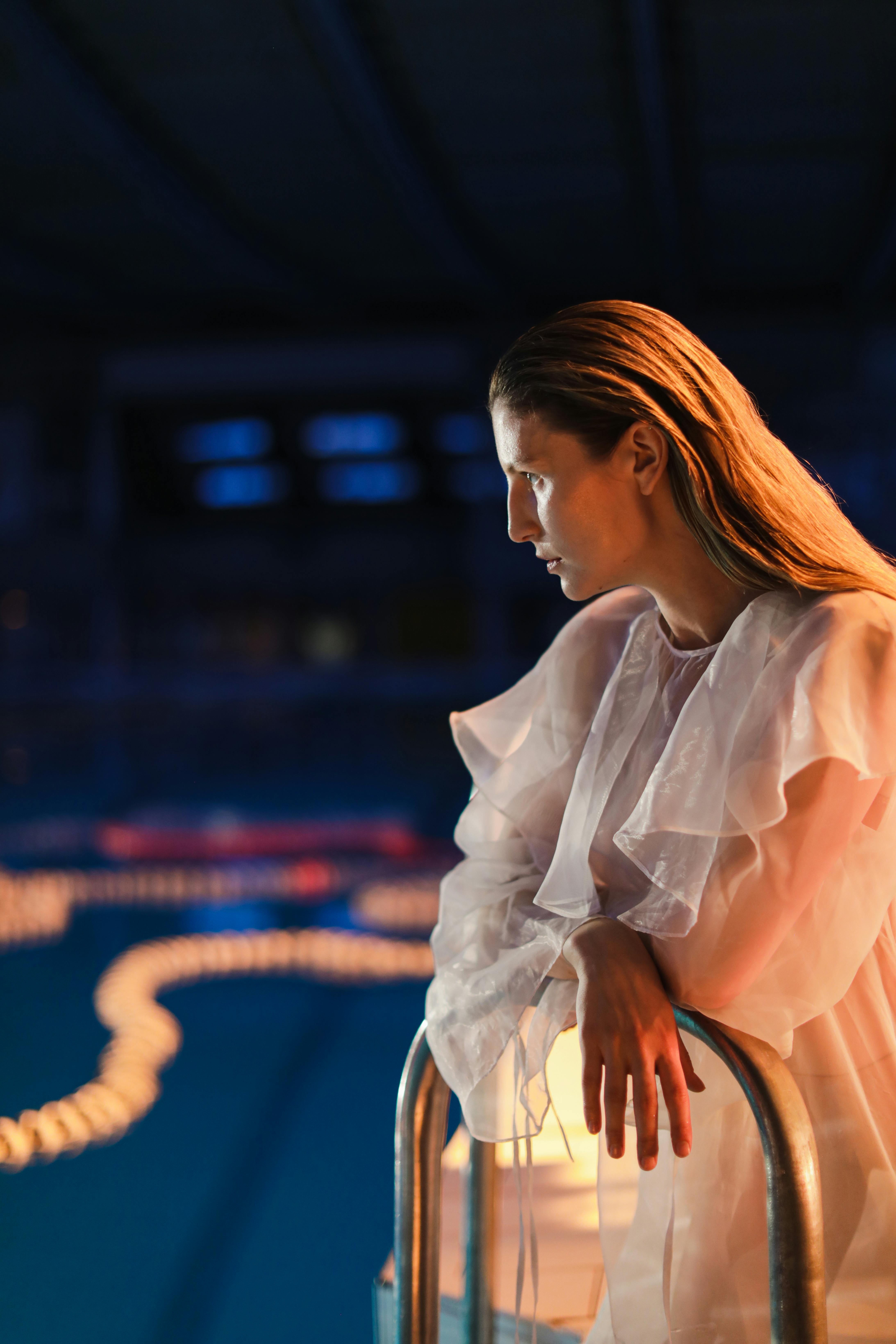 Side View of a Woman near a Swimming Pool · Free Stock Photo