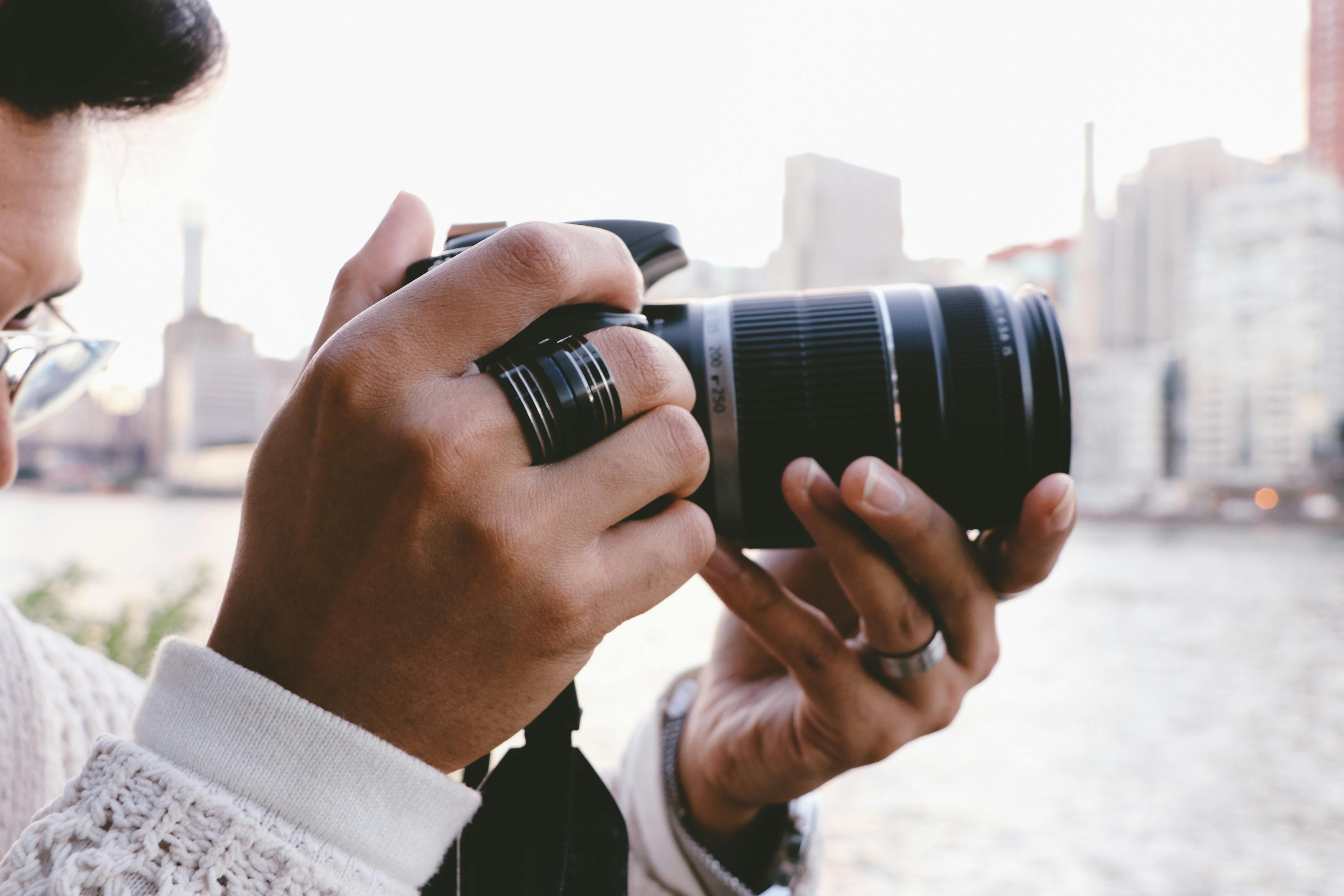 Person Holding Black Dslr Camera · Free Stock Photo