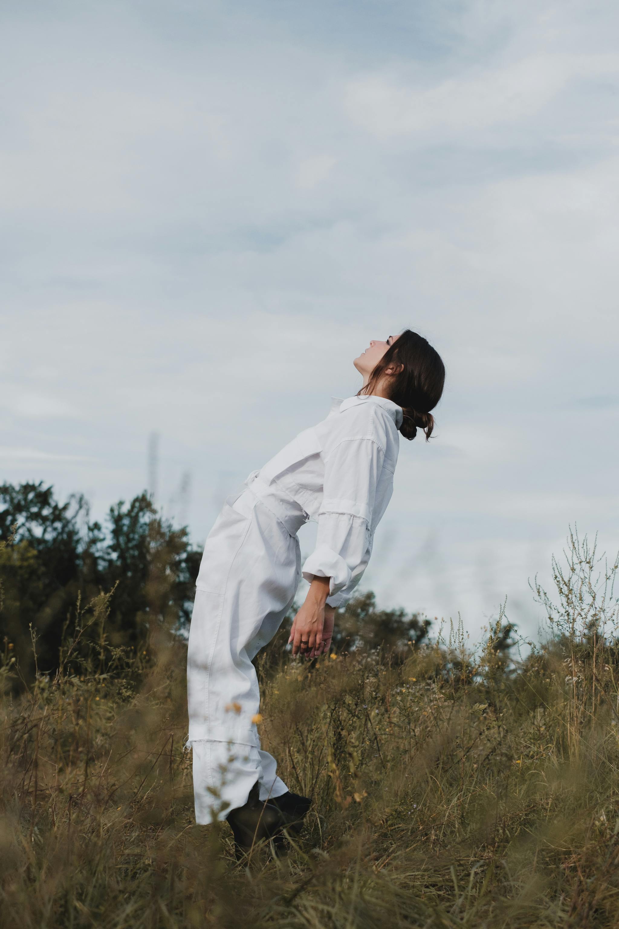 Profile view of standing woman in white clothes · Free Stock Photo