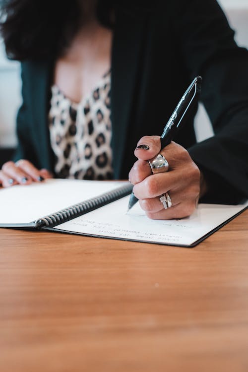 Person Holding Black Pen Writing Notebook · Free Stock Photo Person Holding Black Pen Writing Notebook · Free Stock Photo