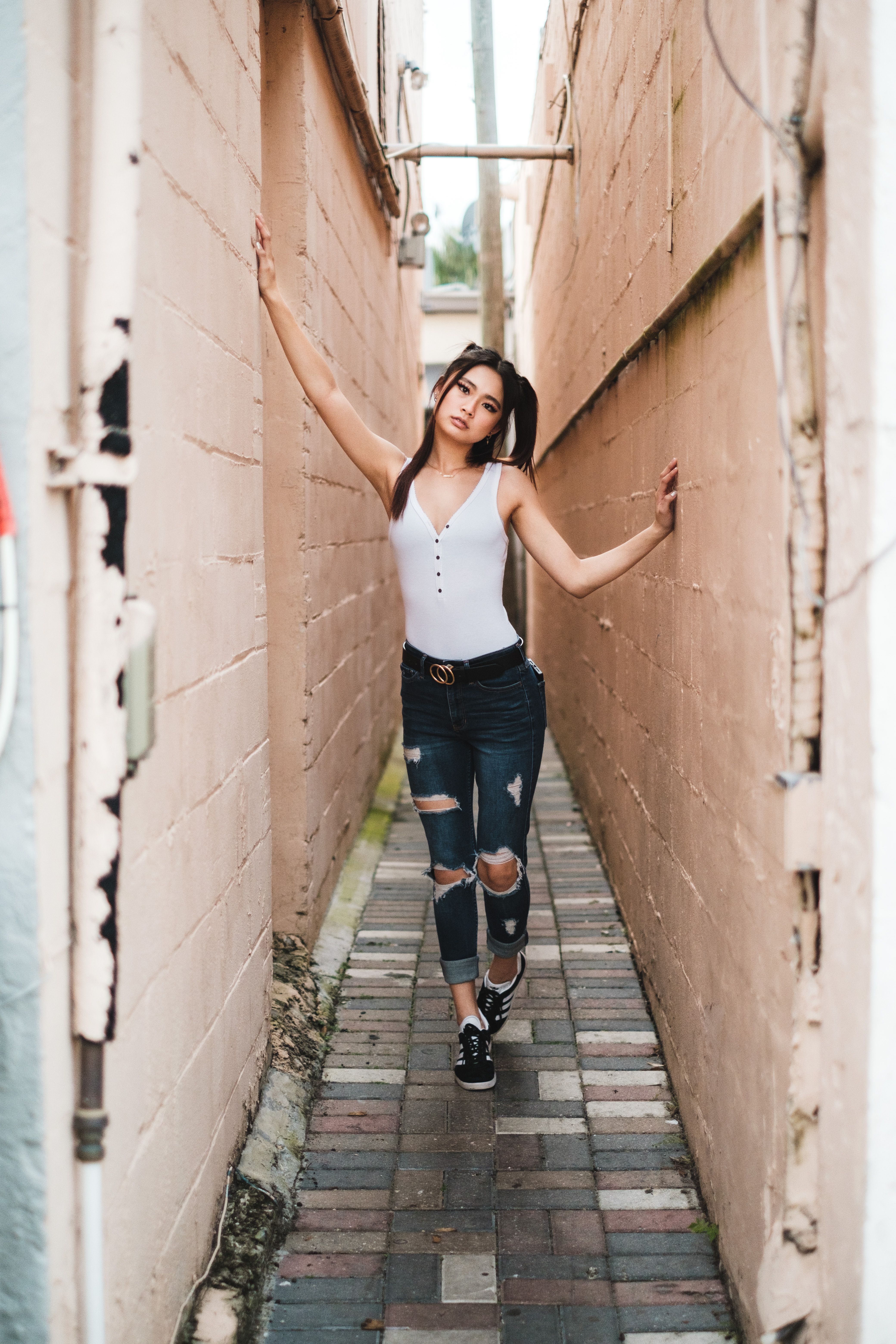 Woman standing between two buildings · Free Stock Photo