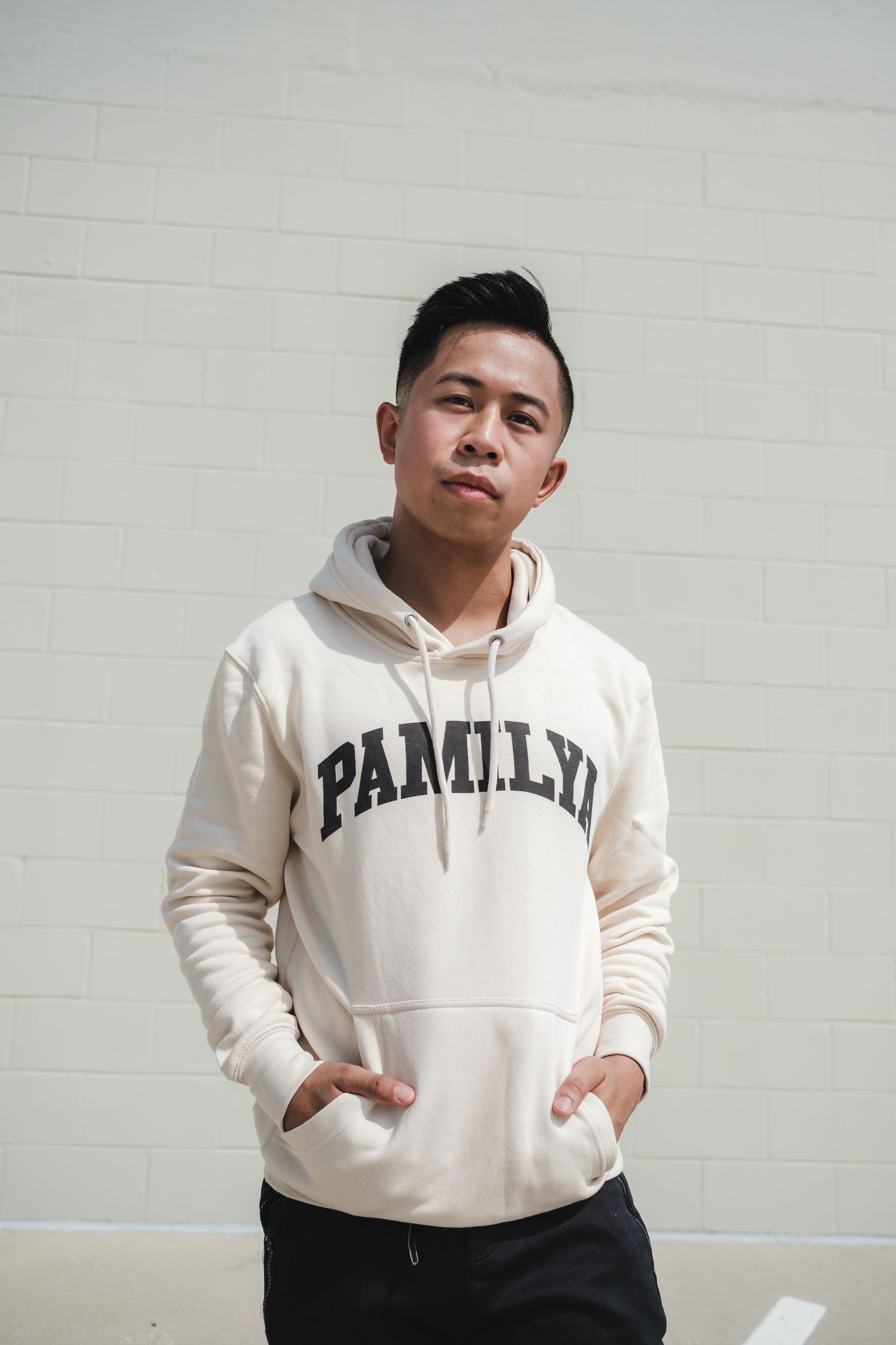 Man in White Hoodie Standing Near White Wall · Free Stock Photo
