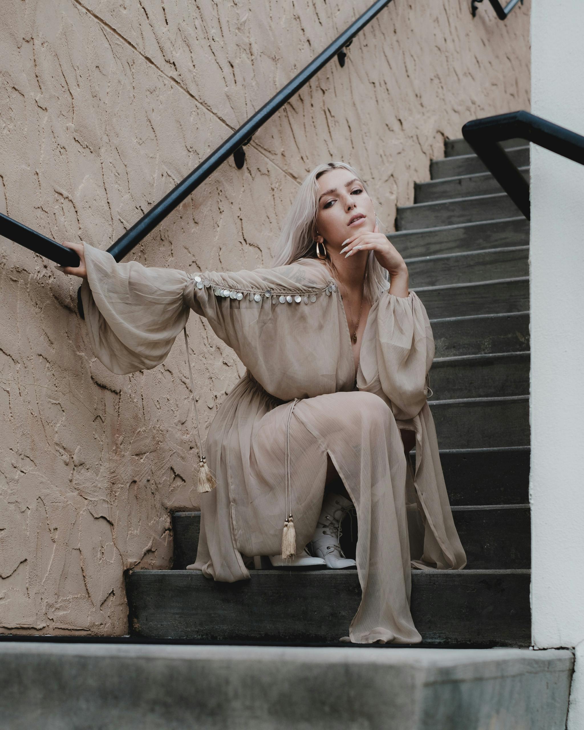 Alluring Woman in a Sheer Dress sitting in a Concrete Staircase · Free ...
