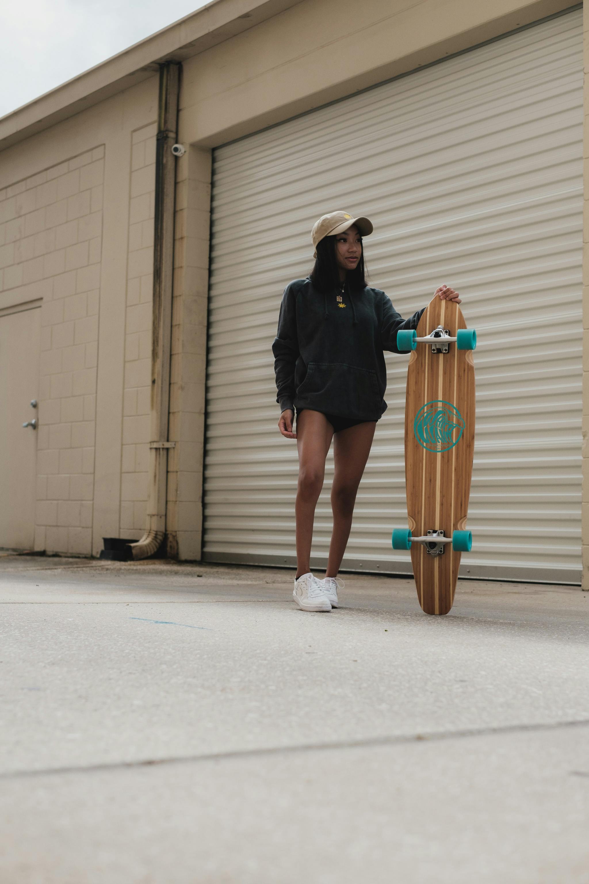 Photo of Woman Posing With Her Longboard · Free Stock Photo