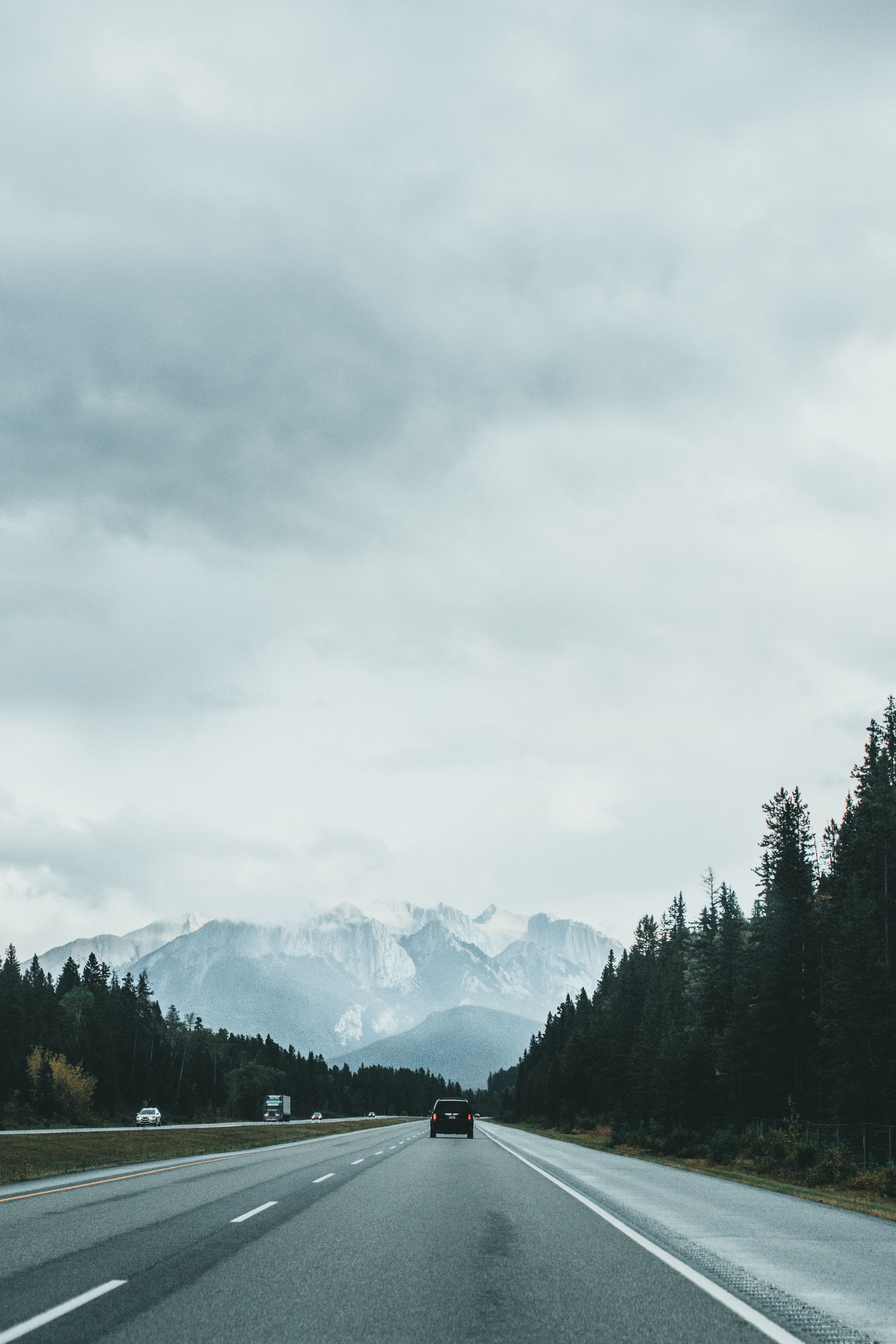 Cars on 4-lane Road Near Valley and Mountain at Daytime · Free Stock Photo