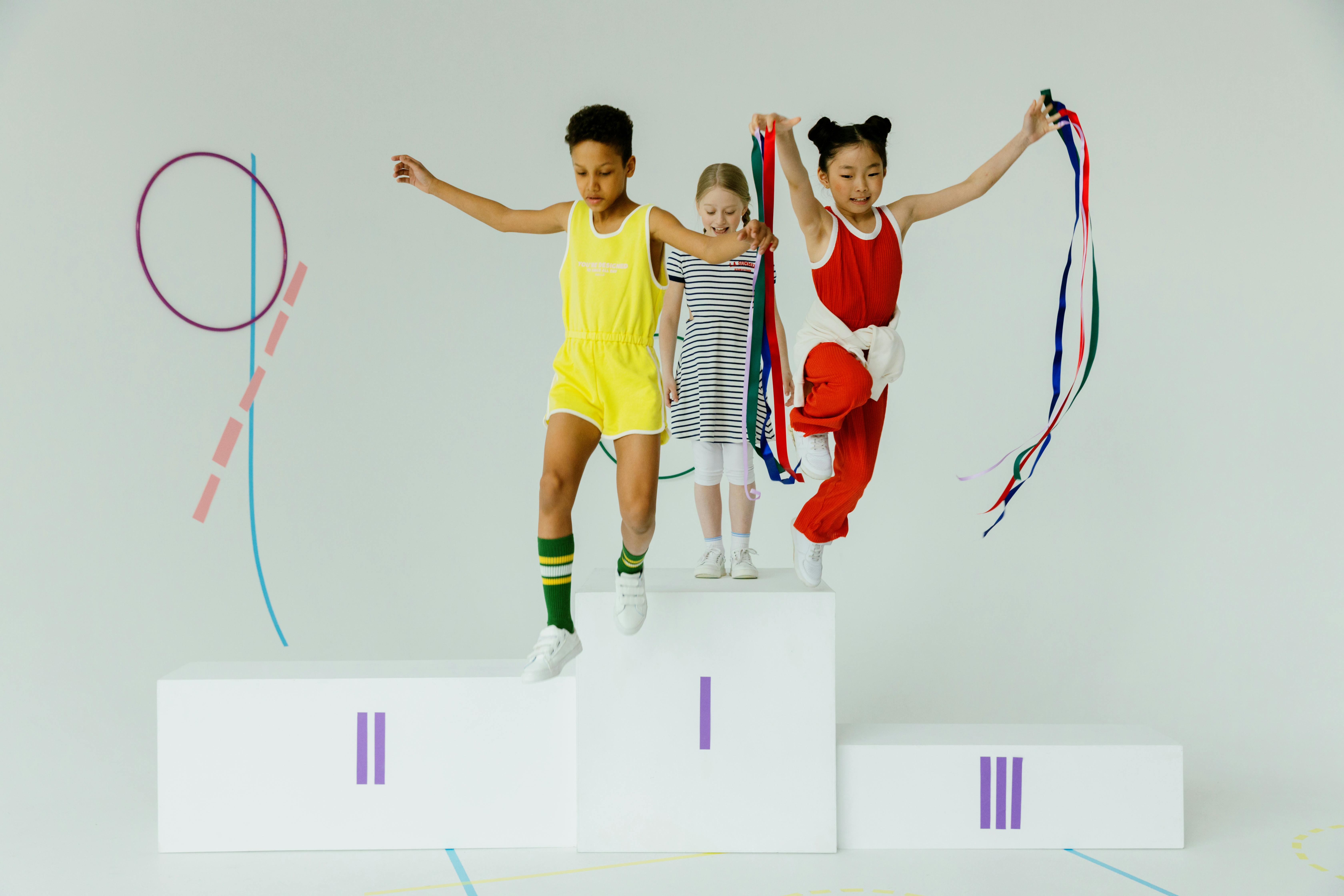 Girls Jumping From Olympic Podium Stand · Free Stock Photo