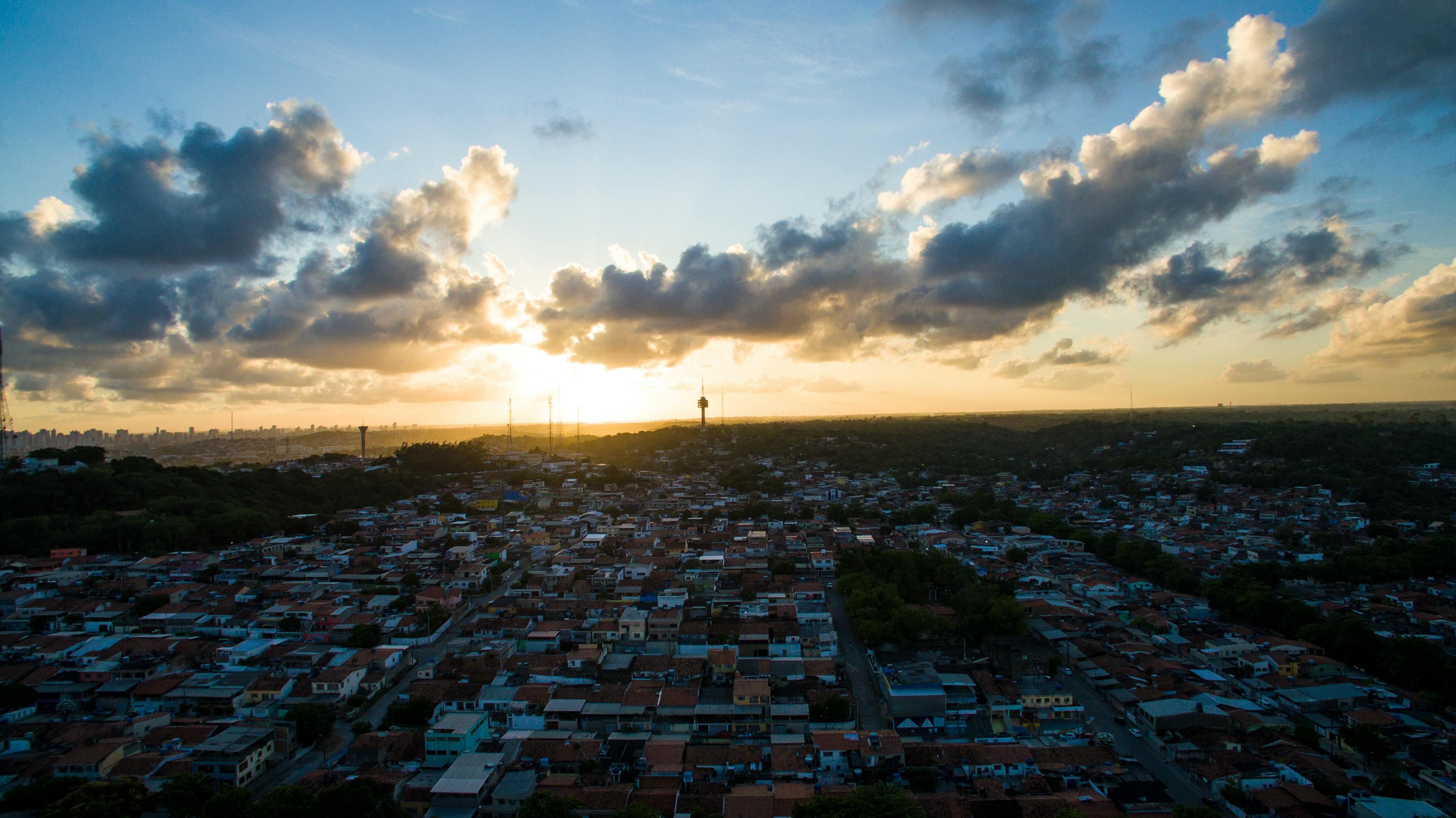 Aerial View of the Houses Under Cloudy Sky · Free Stock Photo