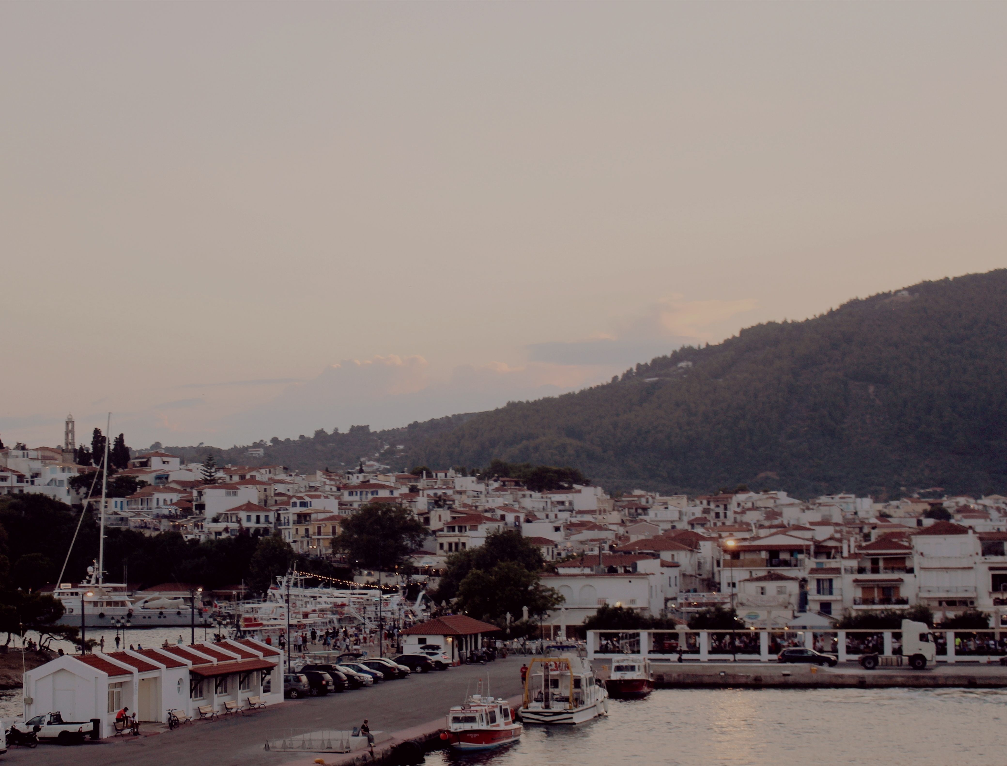 White and Brown Buildings Near Body of Water and Mountain · Free Stock ...