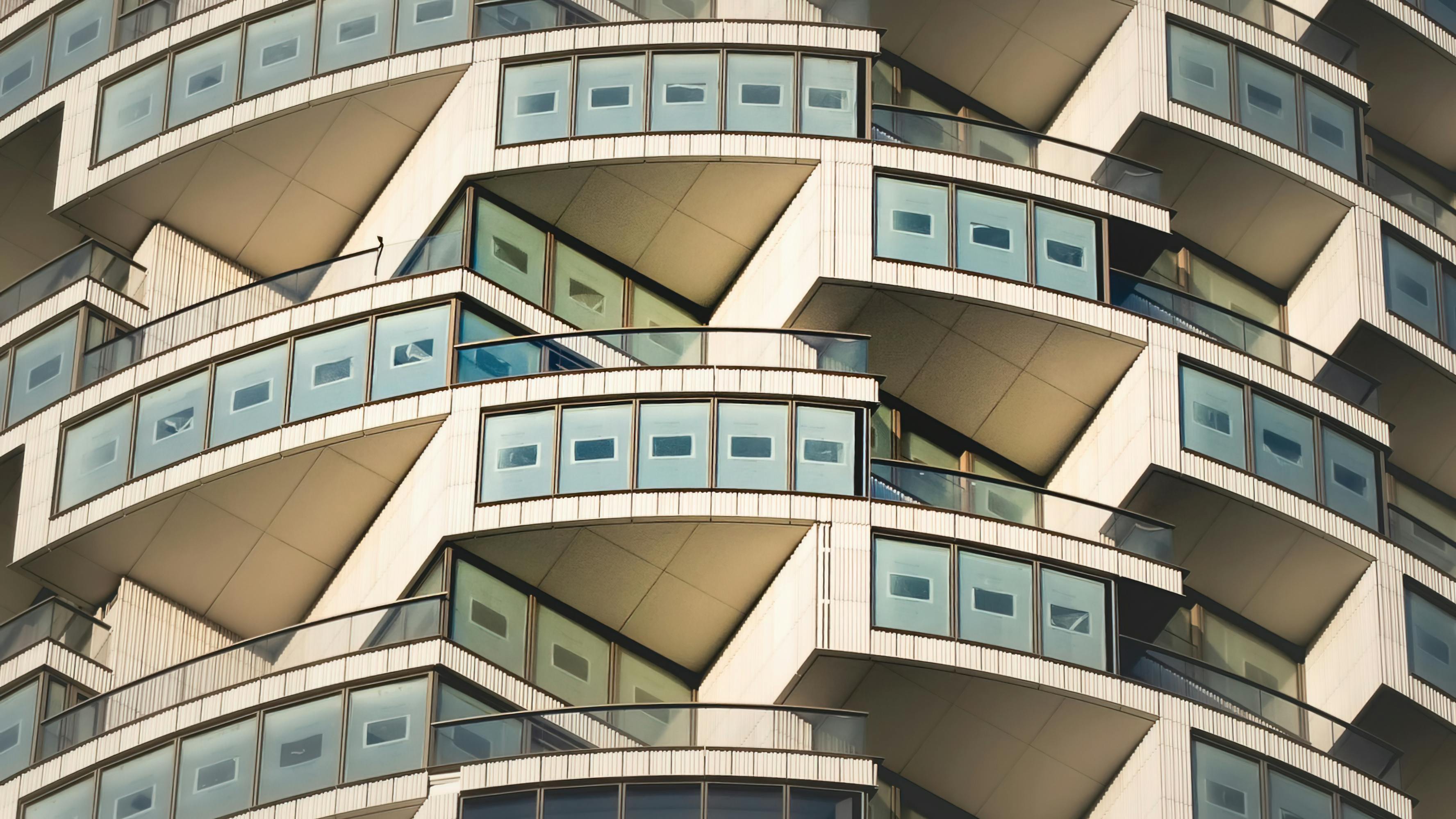 Yellow Facade of the Building with French Balconies and Bay Windows ...