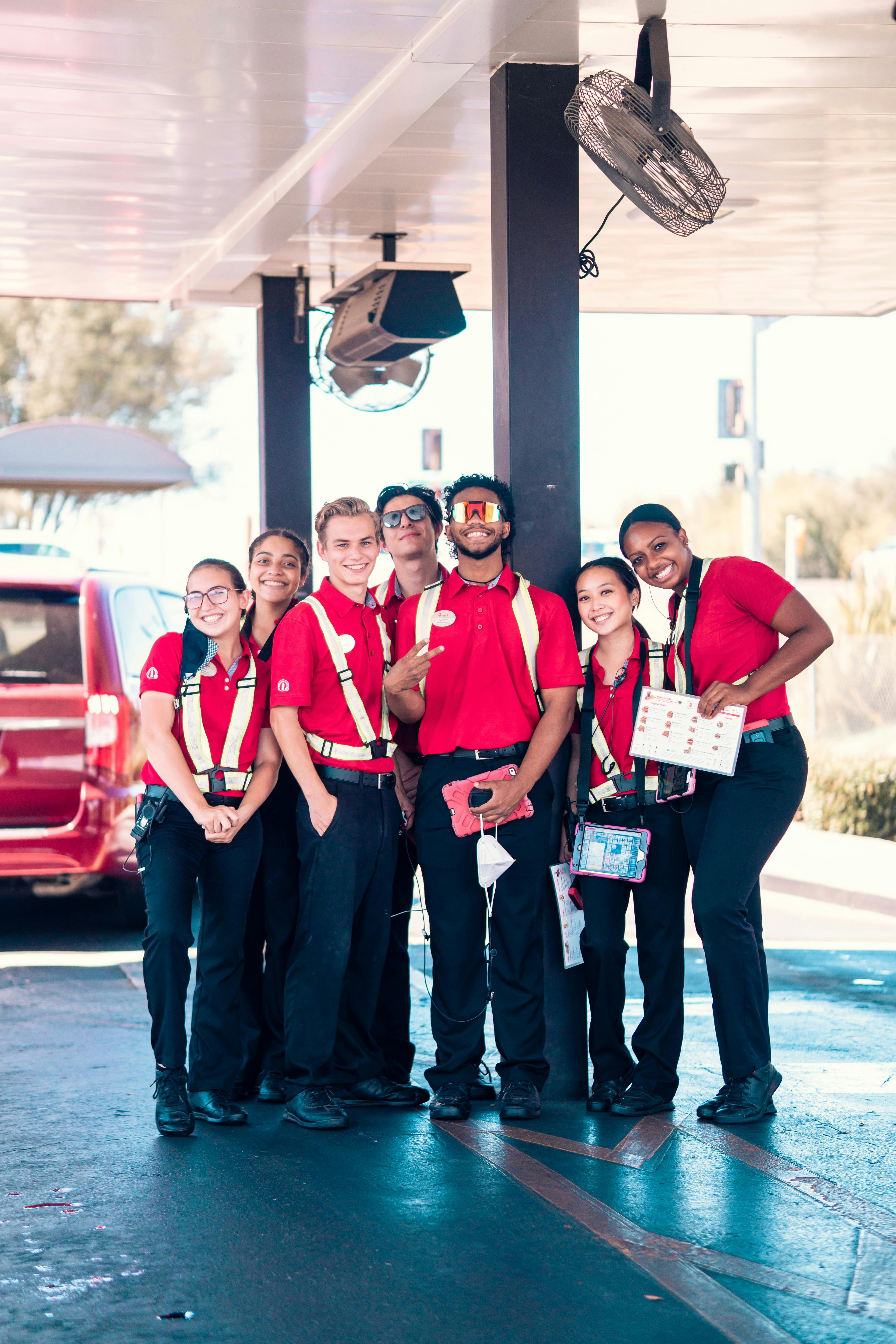 Group of Men and Women Wearing Red and White Uniform · Free Stock Photo