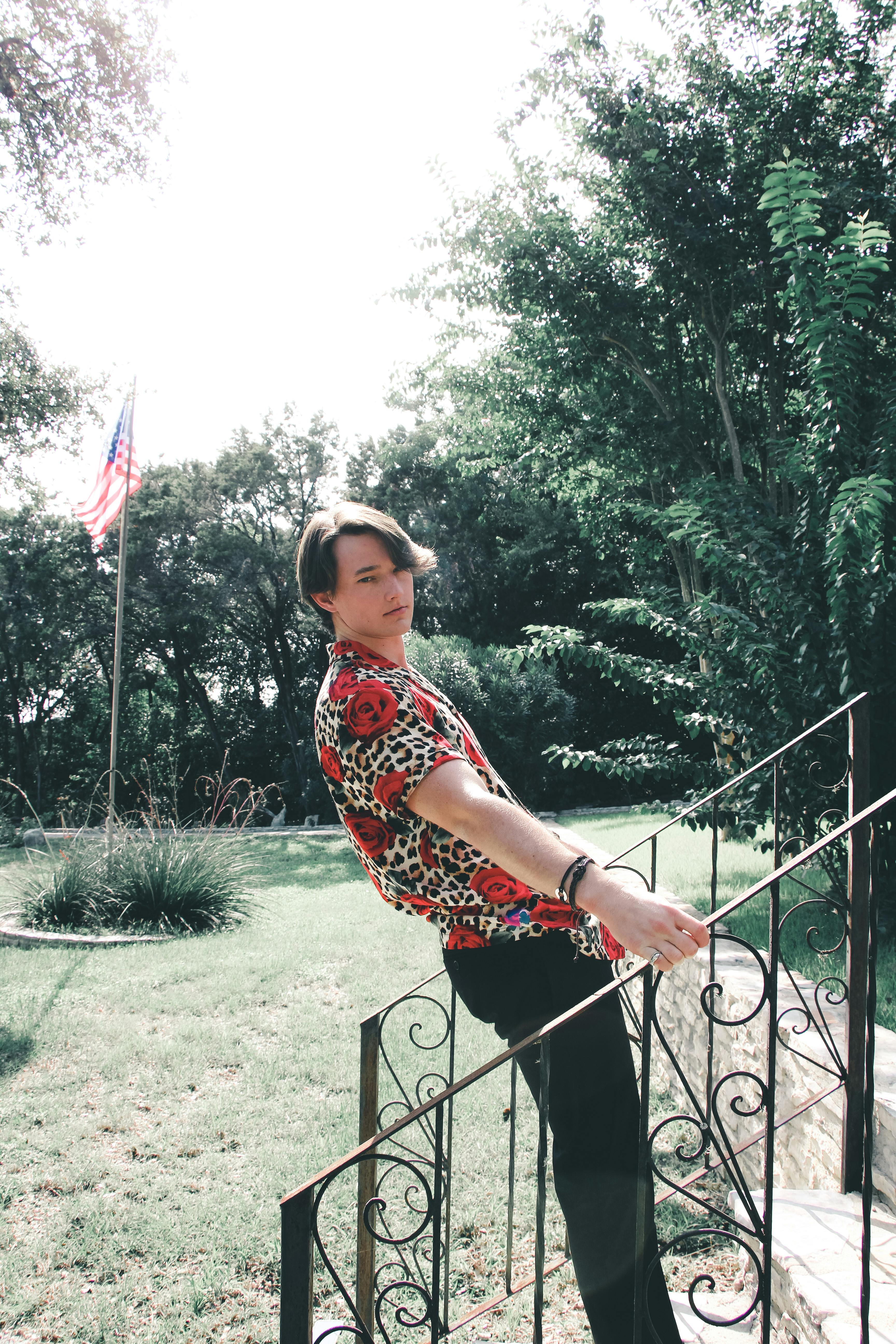 Man Leaning on Metal Railing Spinning a Basketball on His Finger · Free ...