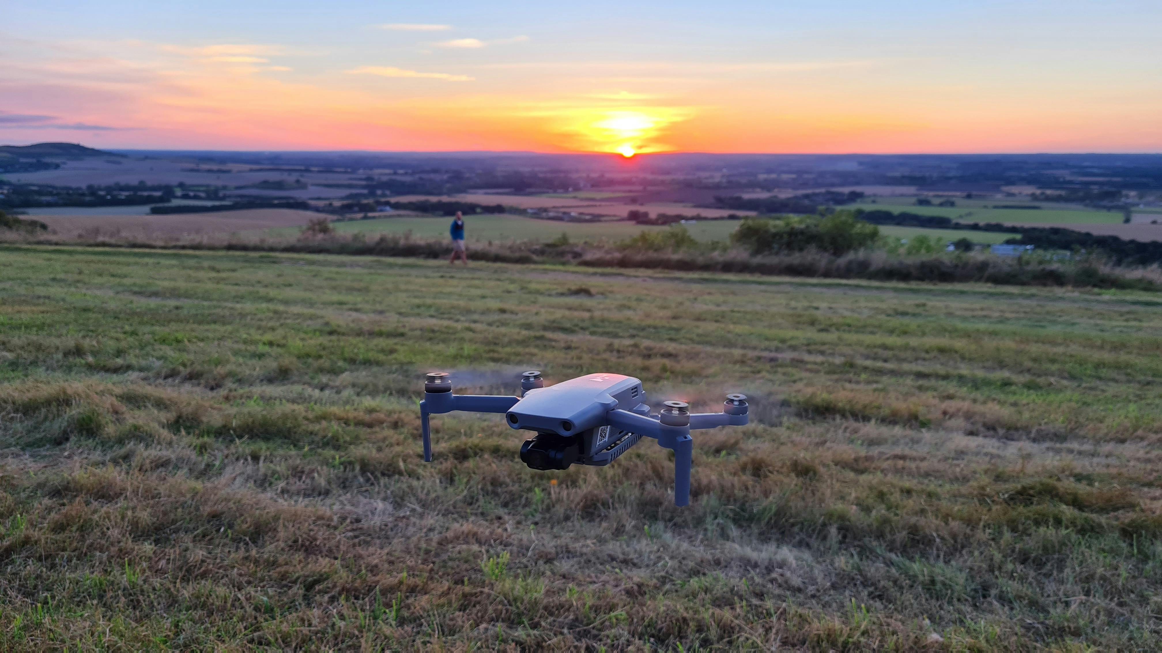 Drone Flying Over a Grass Field · Free Stock Photo