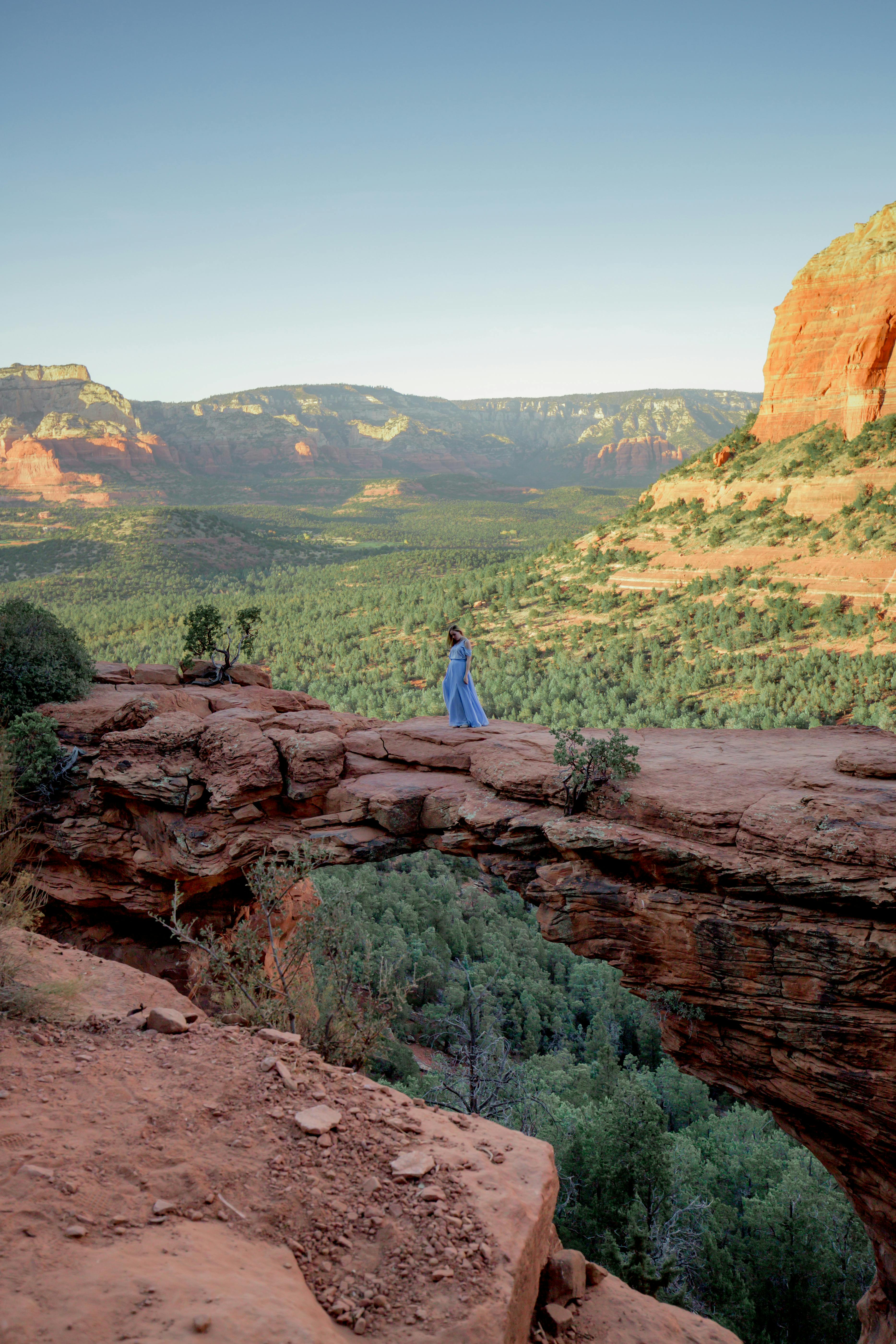 A Woman Standing on the Rock Formation · Free Stock Photo