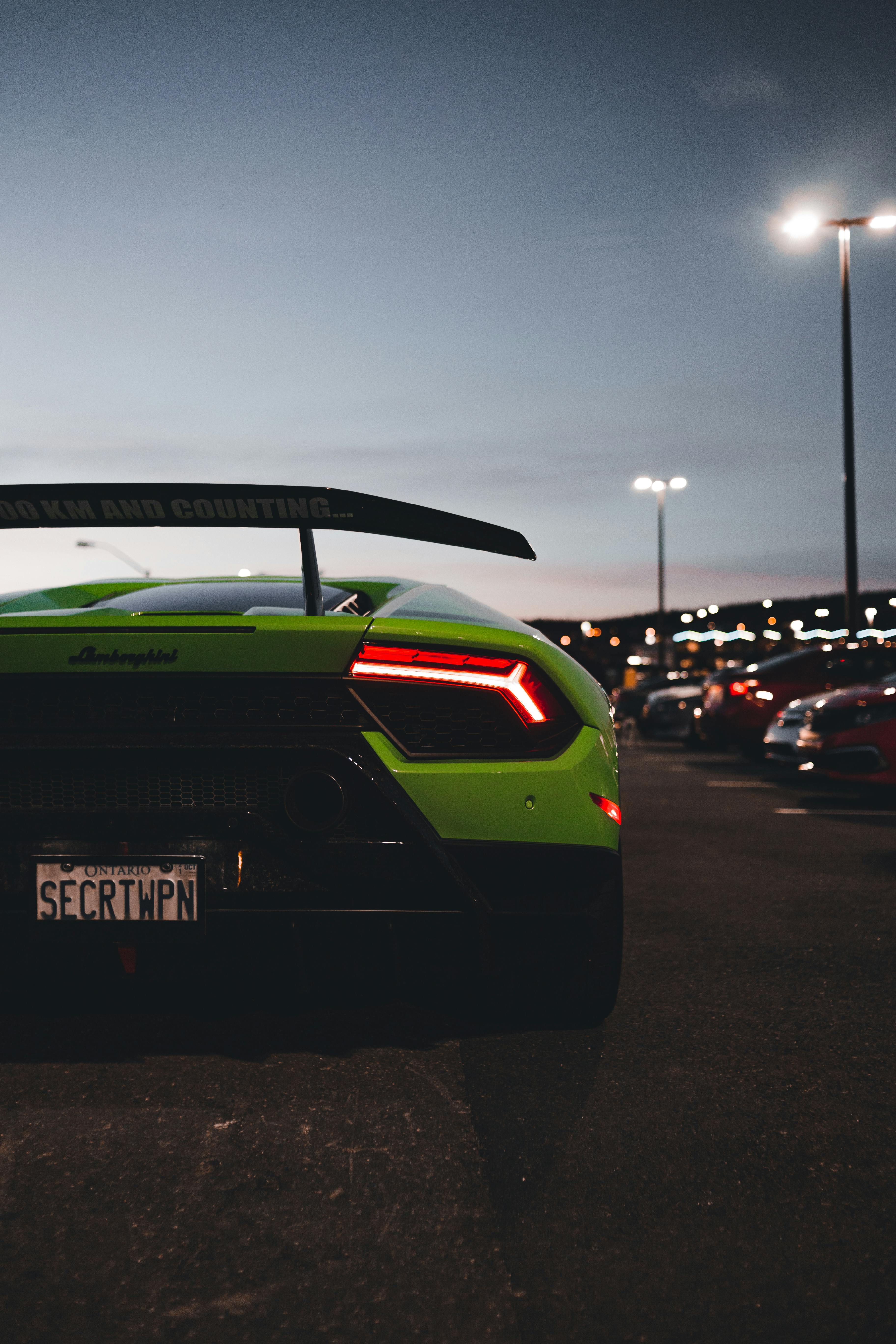 A Sports Car Parked on the Concrete Pavement · Free Stock Photo
