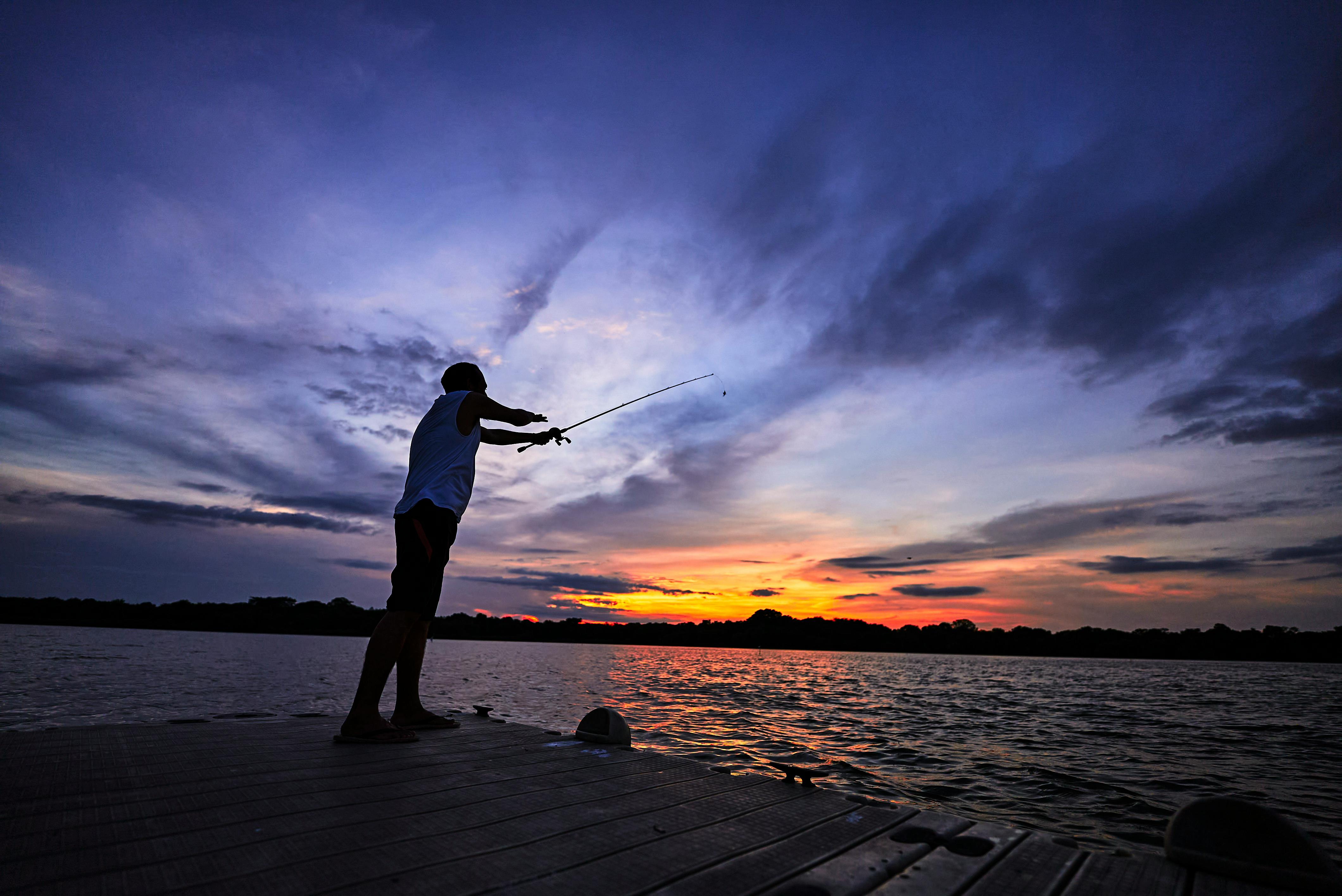 Silhouette of a Person Standing on Wooden Dock while Fishing · Free ...