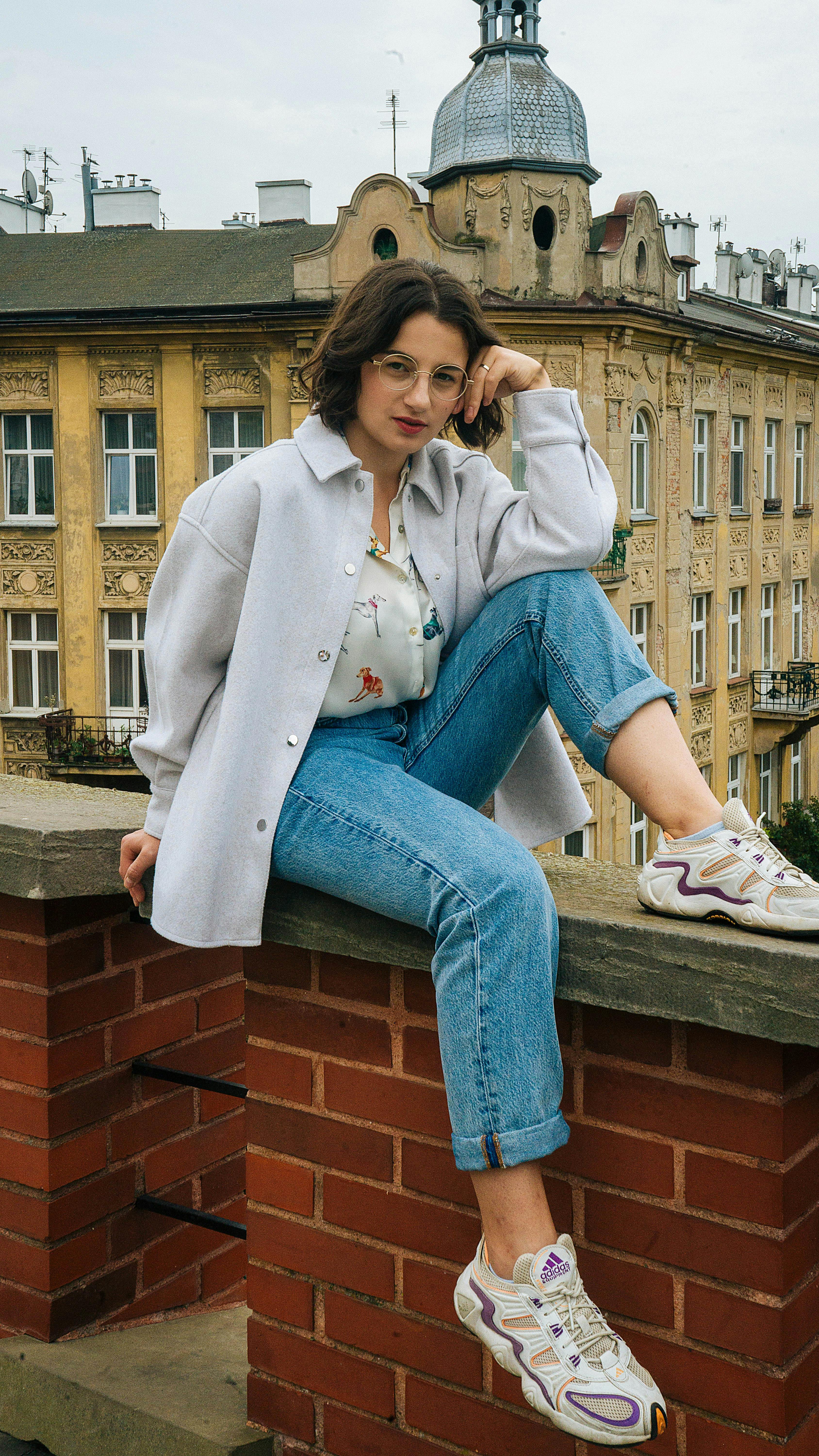 Woman Sitting on the Rooftop Fence · Free Stock Photo