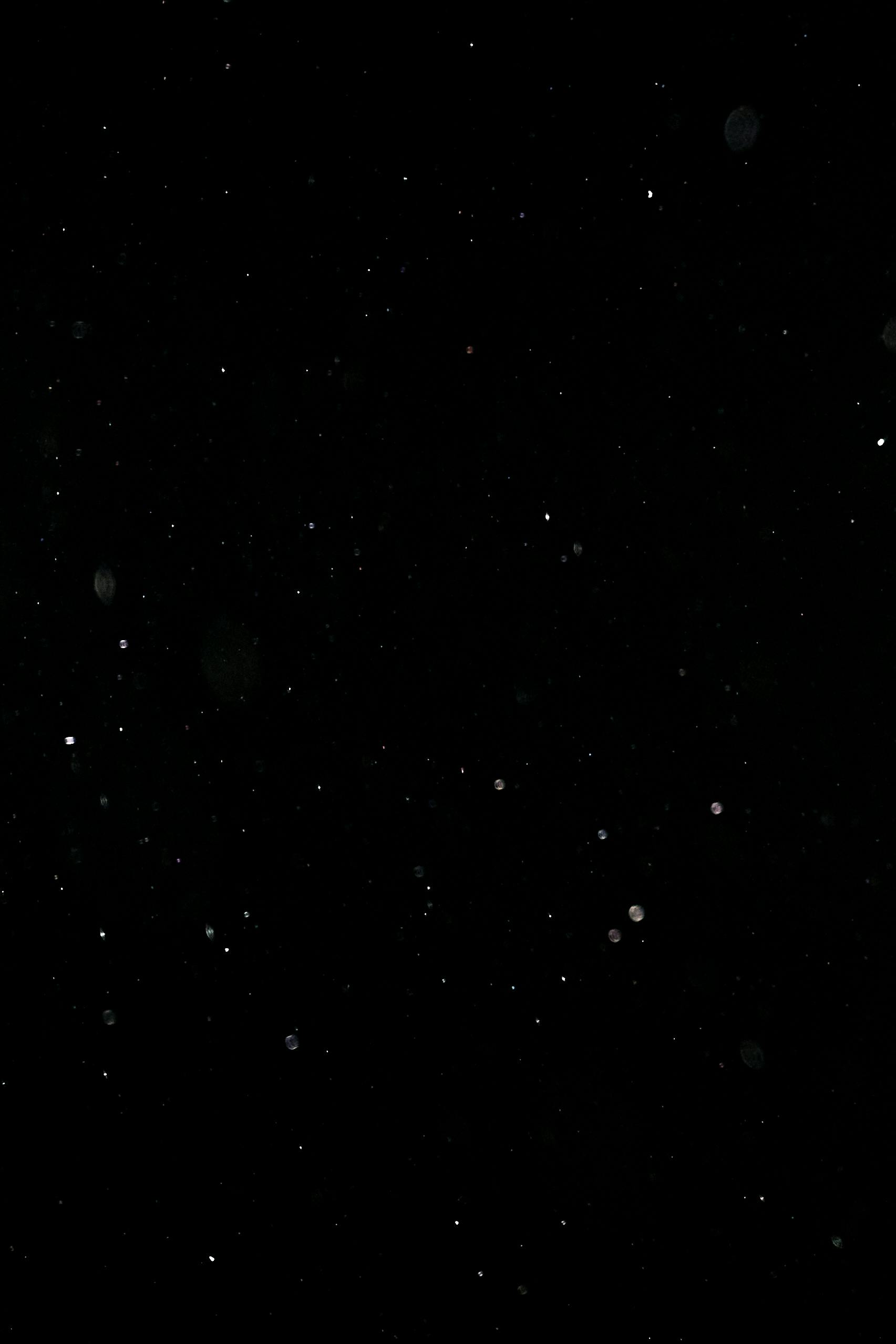 Tiny White Dust Particles on Black Background · Free Stock Photo