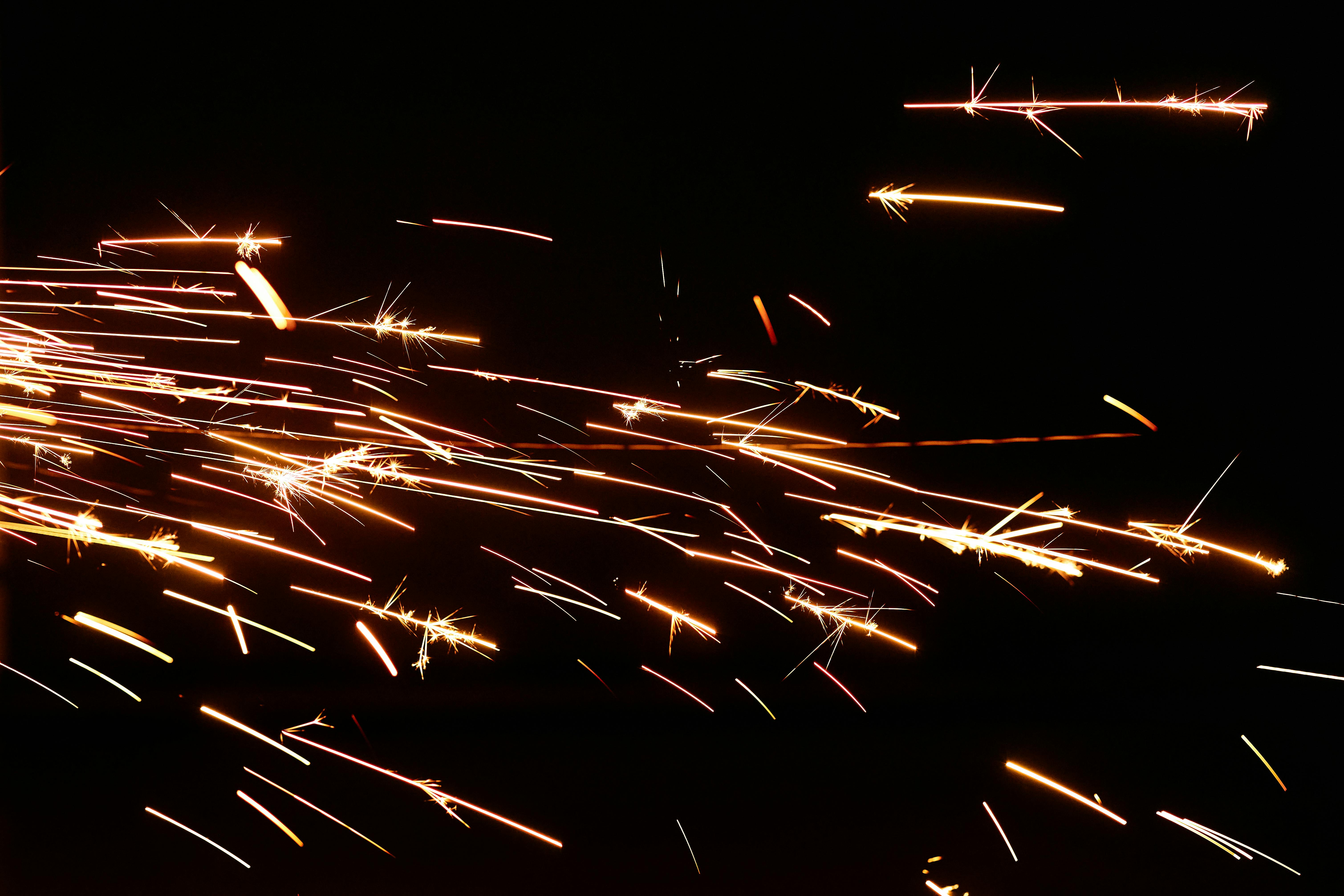 Close-Up Photo of Flashing Sparks on Black Background · Free Stock Photo
