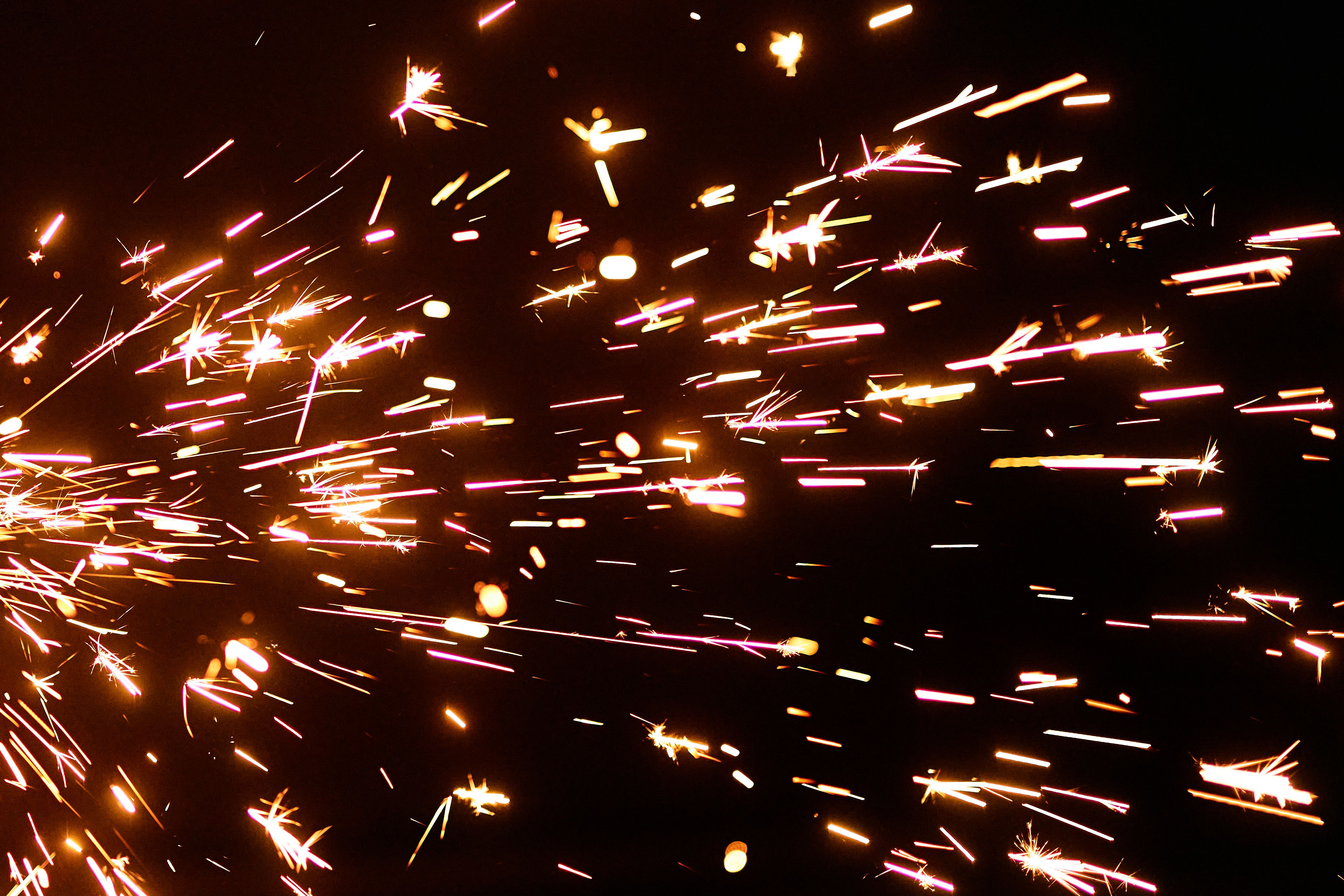 Close-Up Photo of Flashing Sparks on Black Background · Free Stock Photo