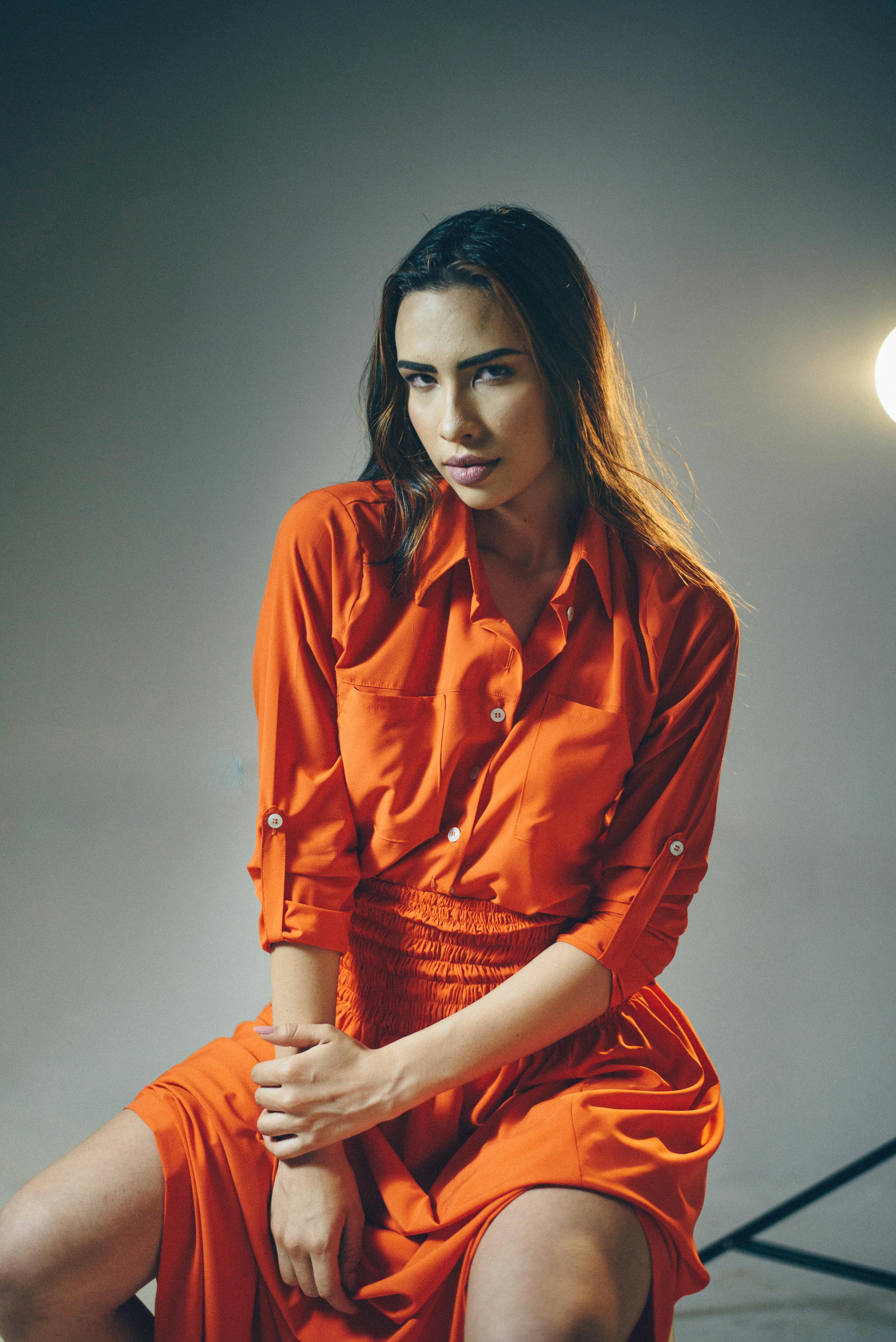 A Woman Wearing Orange Dress While Posing · Free Stock Photo