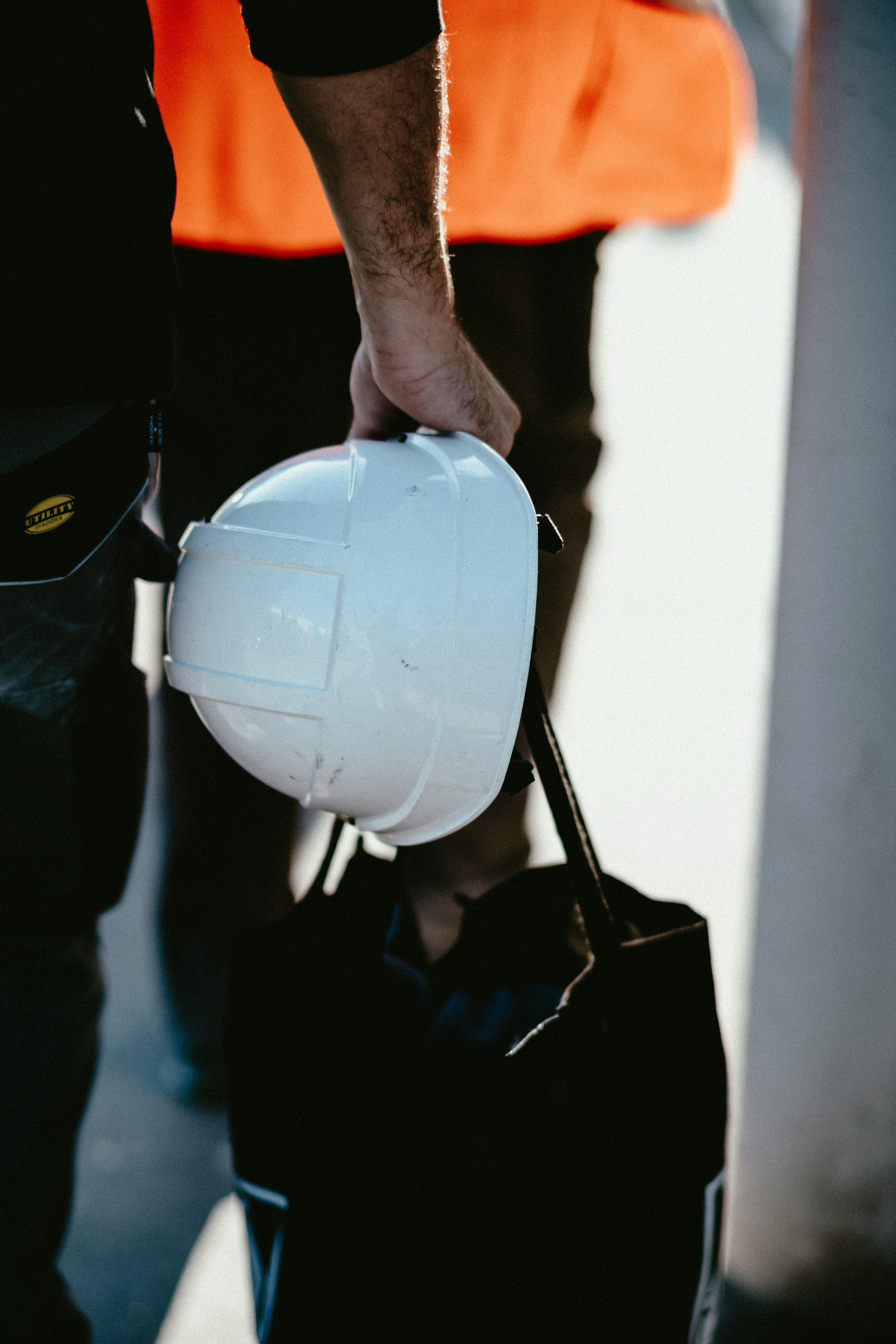 Person Carrying a White Safety Helmet · Free Stock Photo