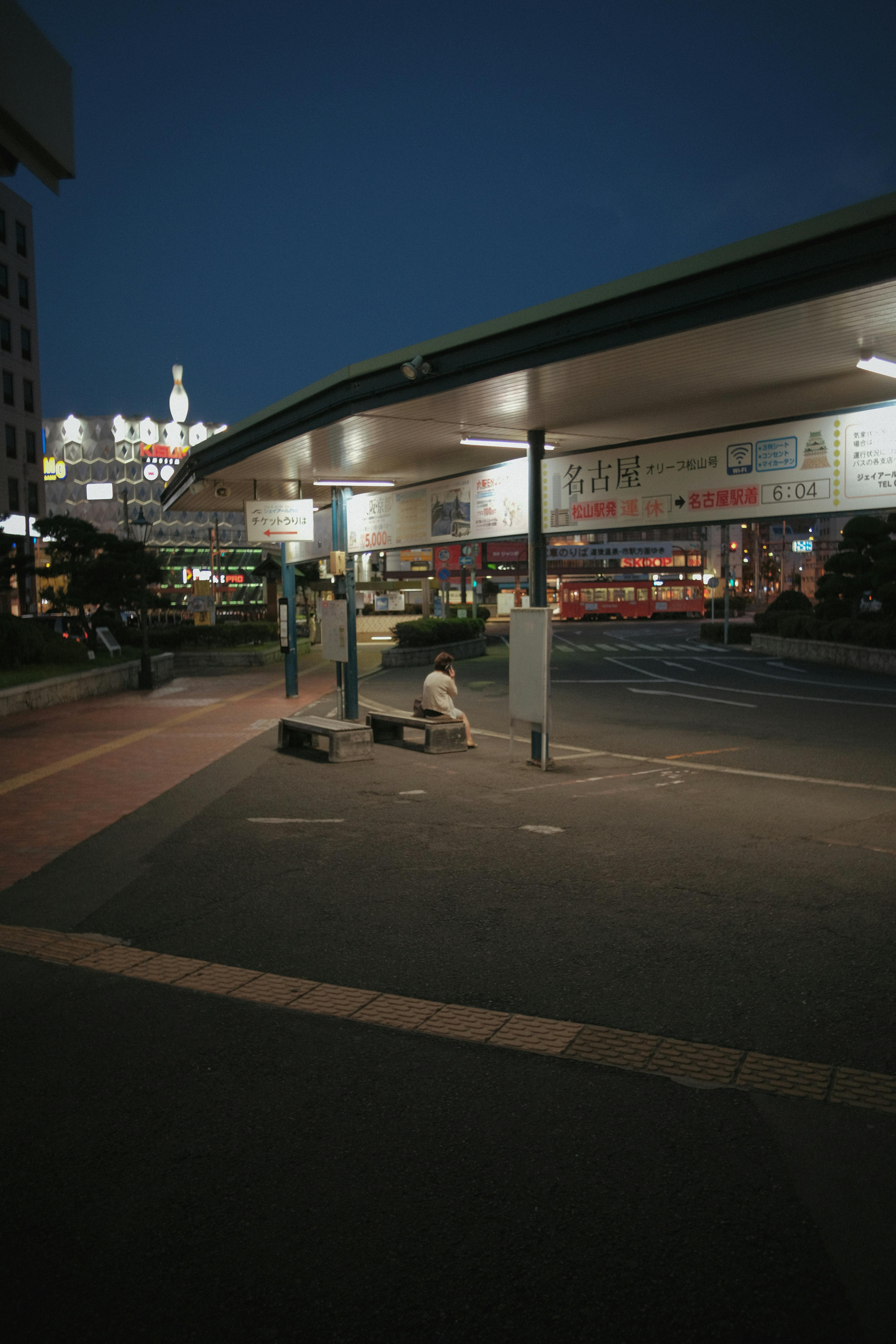 Man Wearing Sunglasses Sitting at Bus Stop during Daytime · Free Stock ...