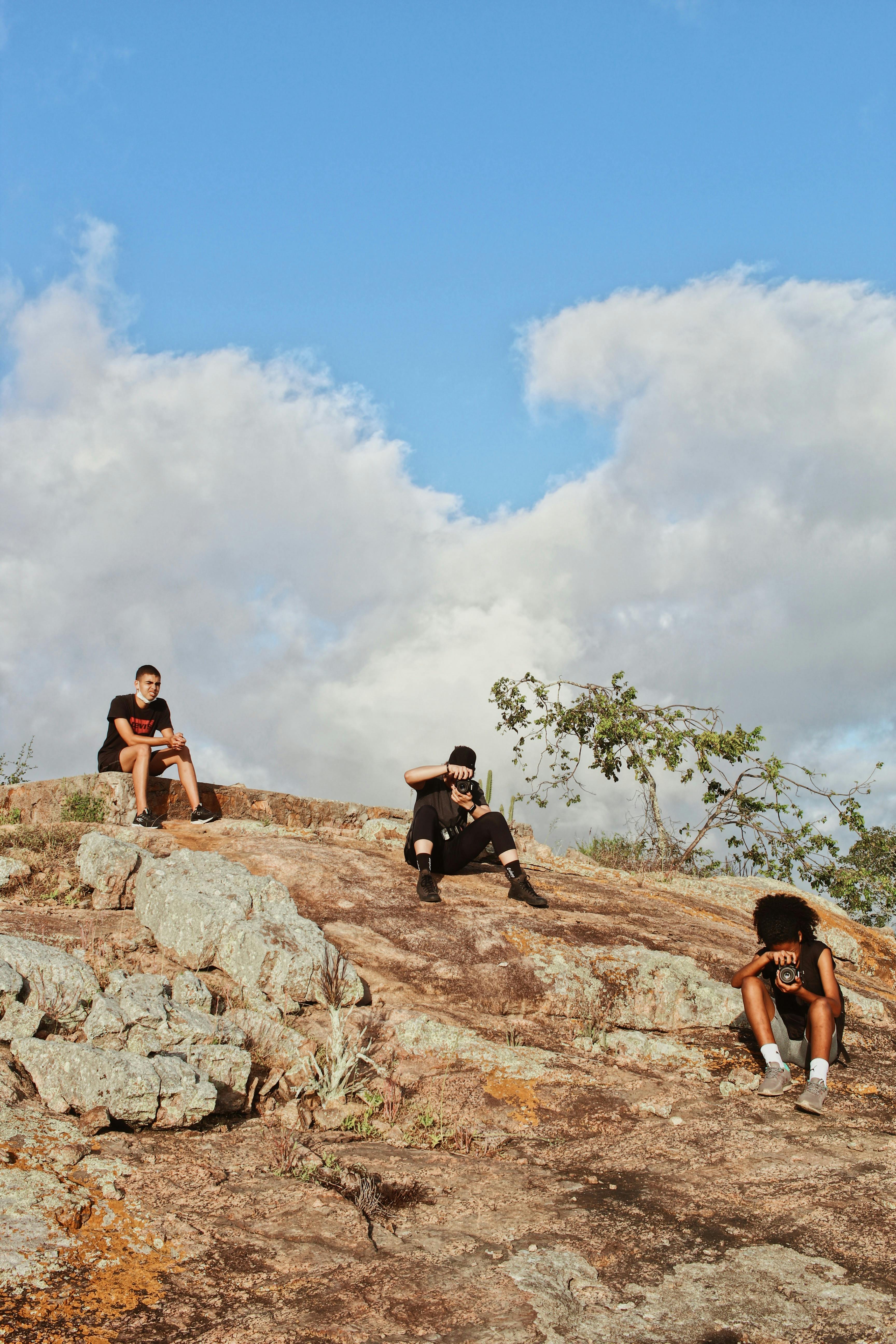 People Taking a Photo while Sitting on the Ground · Free Stock Photo