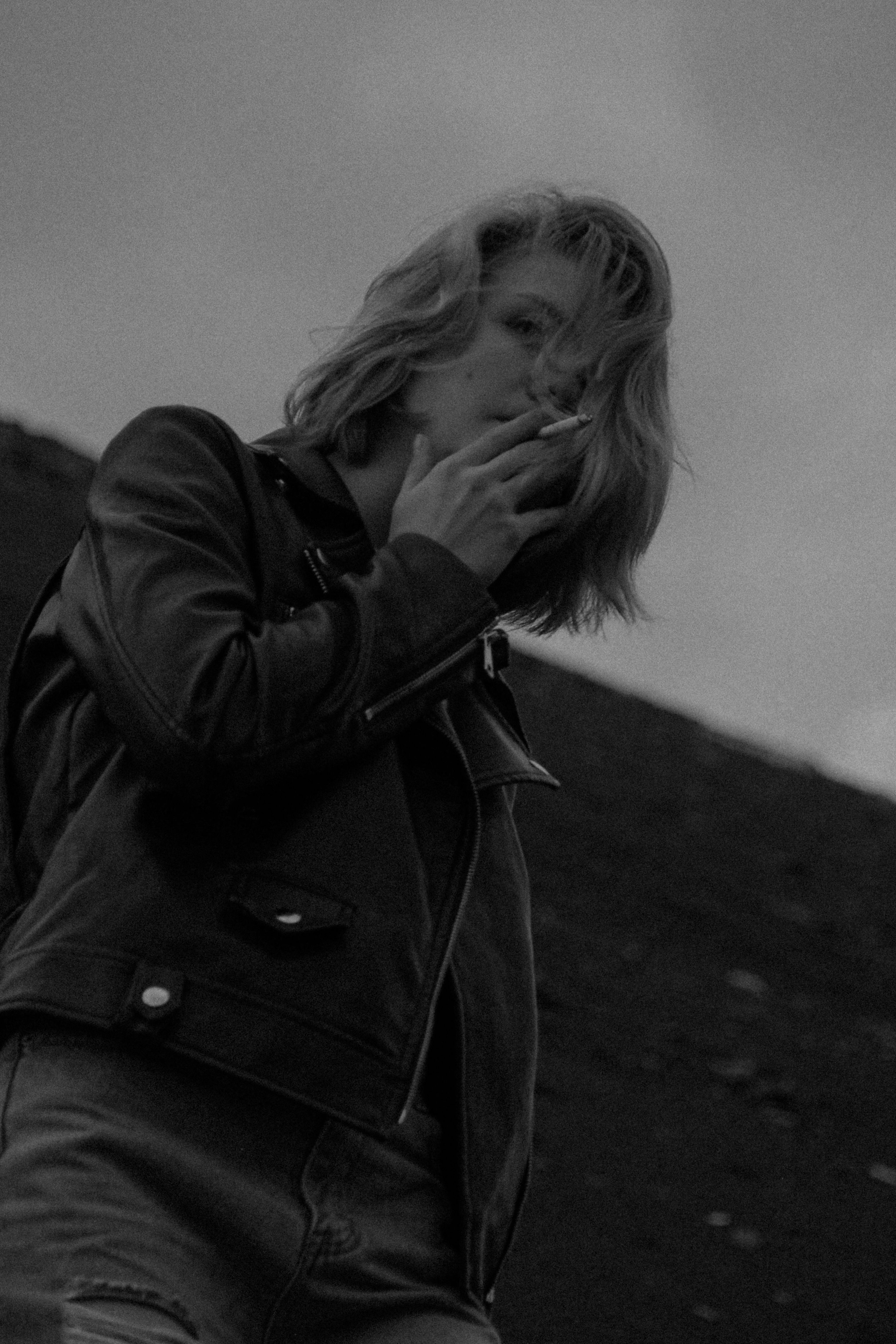 Person in Black Leather Jacket Smoking a Cigarette · Free Stock Photo