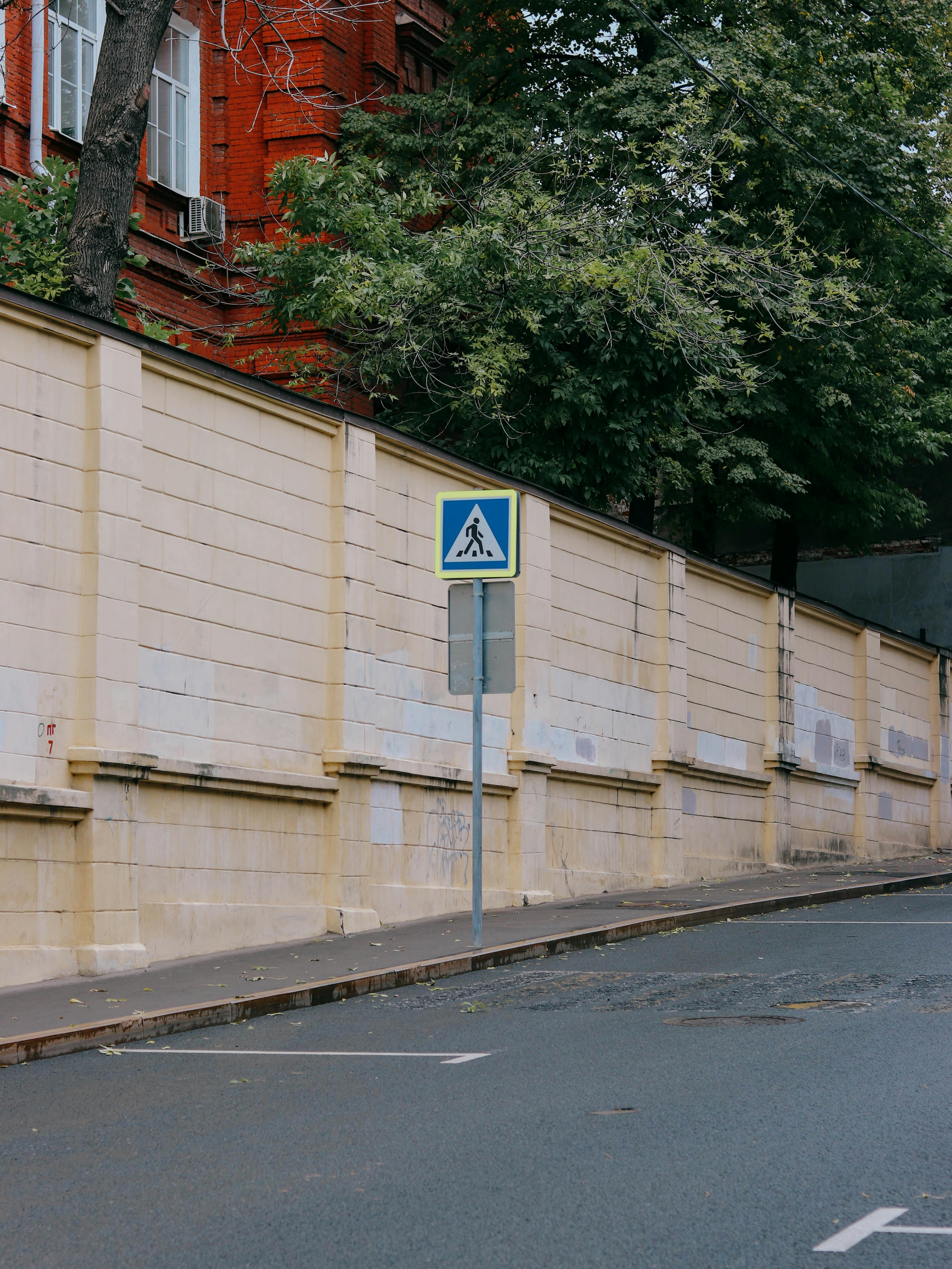 Road Sign on Sidewalk · Free Stock Photo