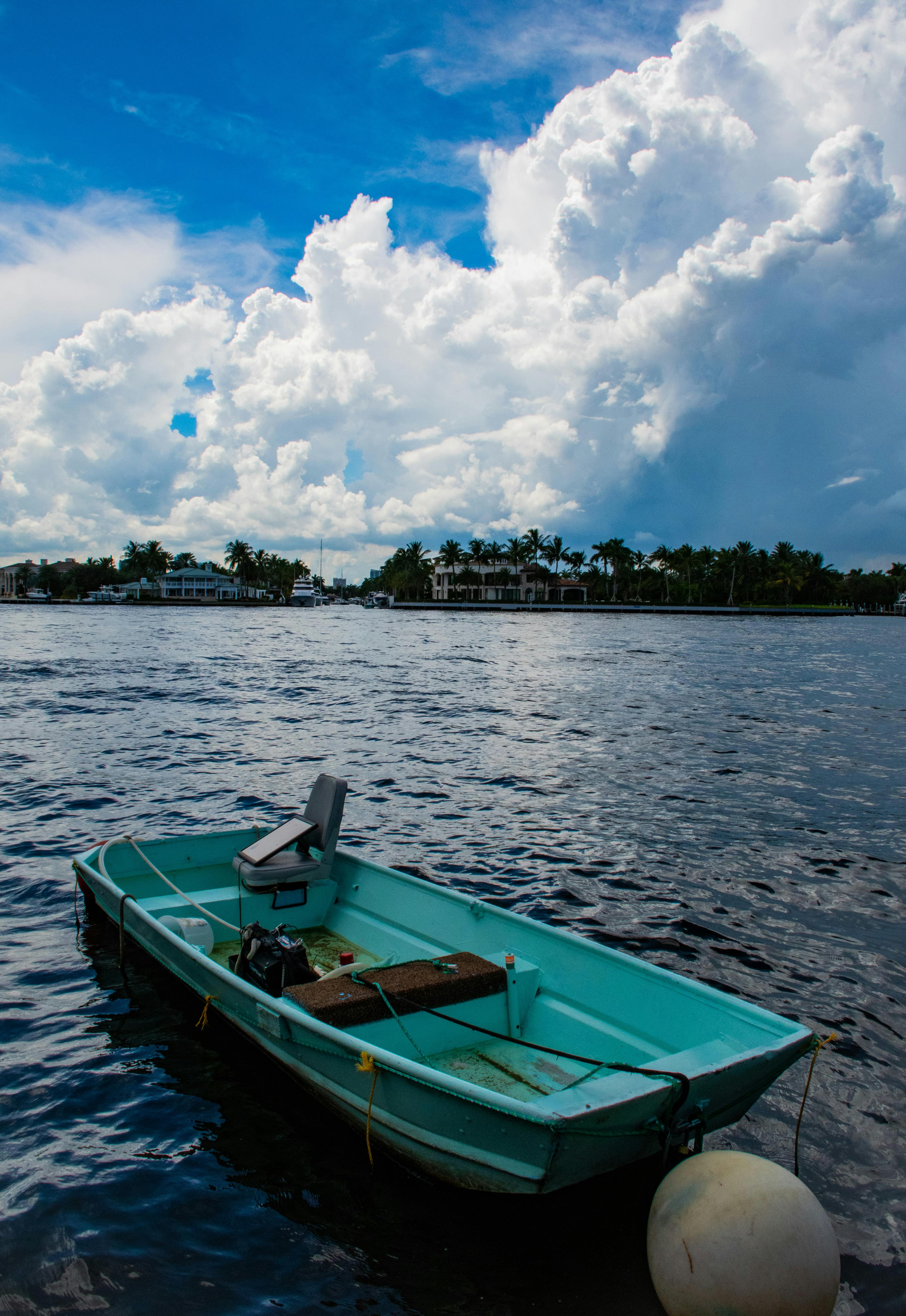 Teal Boat on Body of Water · Free Stock Photo