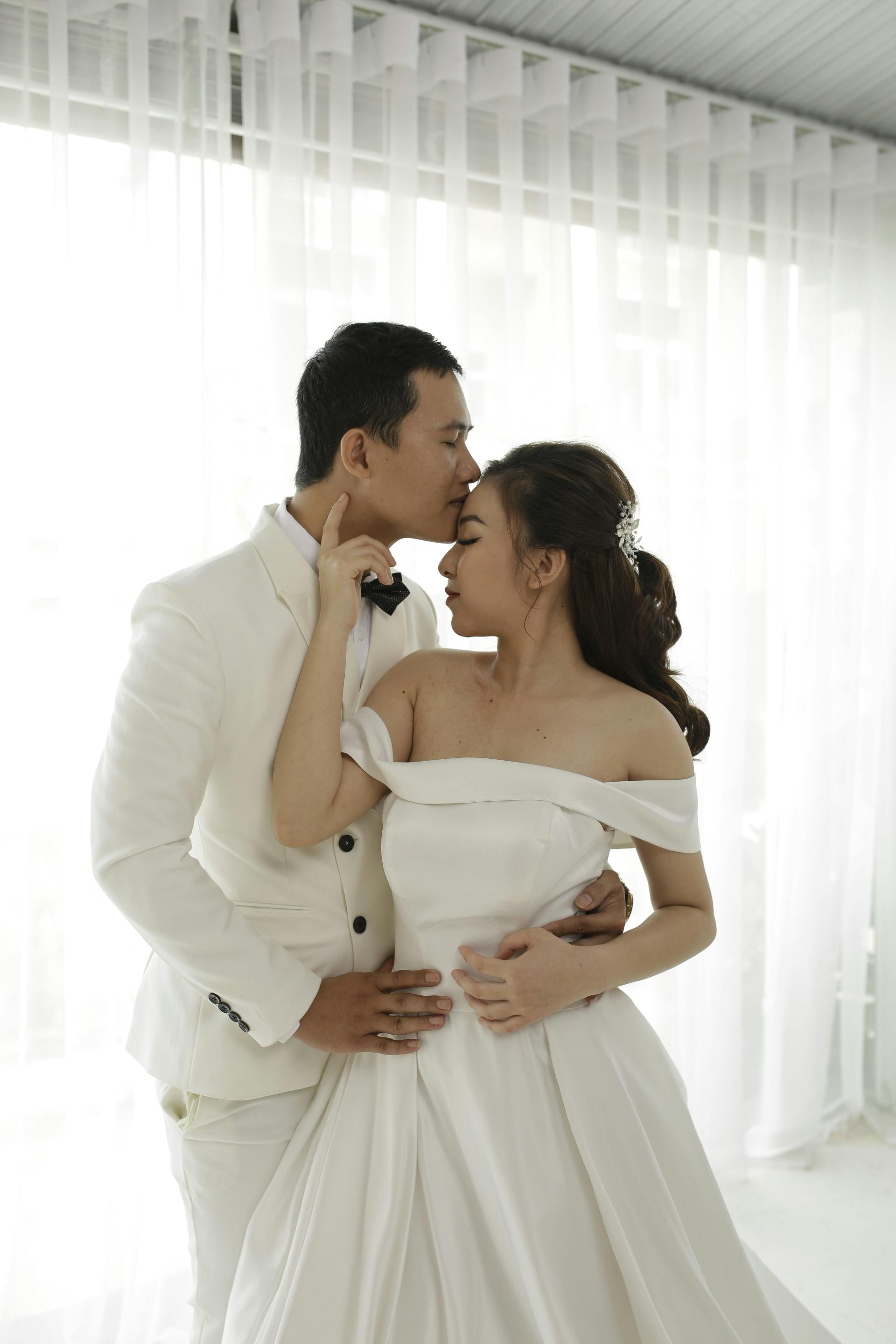 A Groom Kissing the Bride on the Head · Free Stock Photo