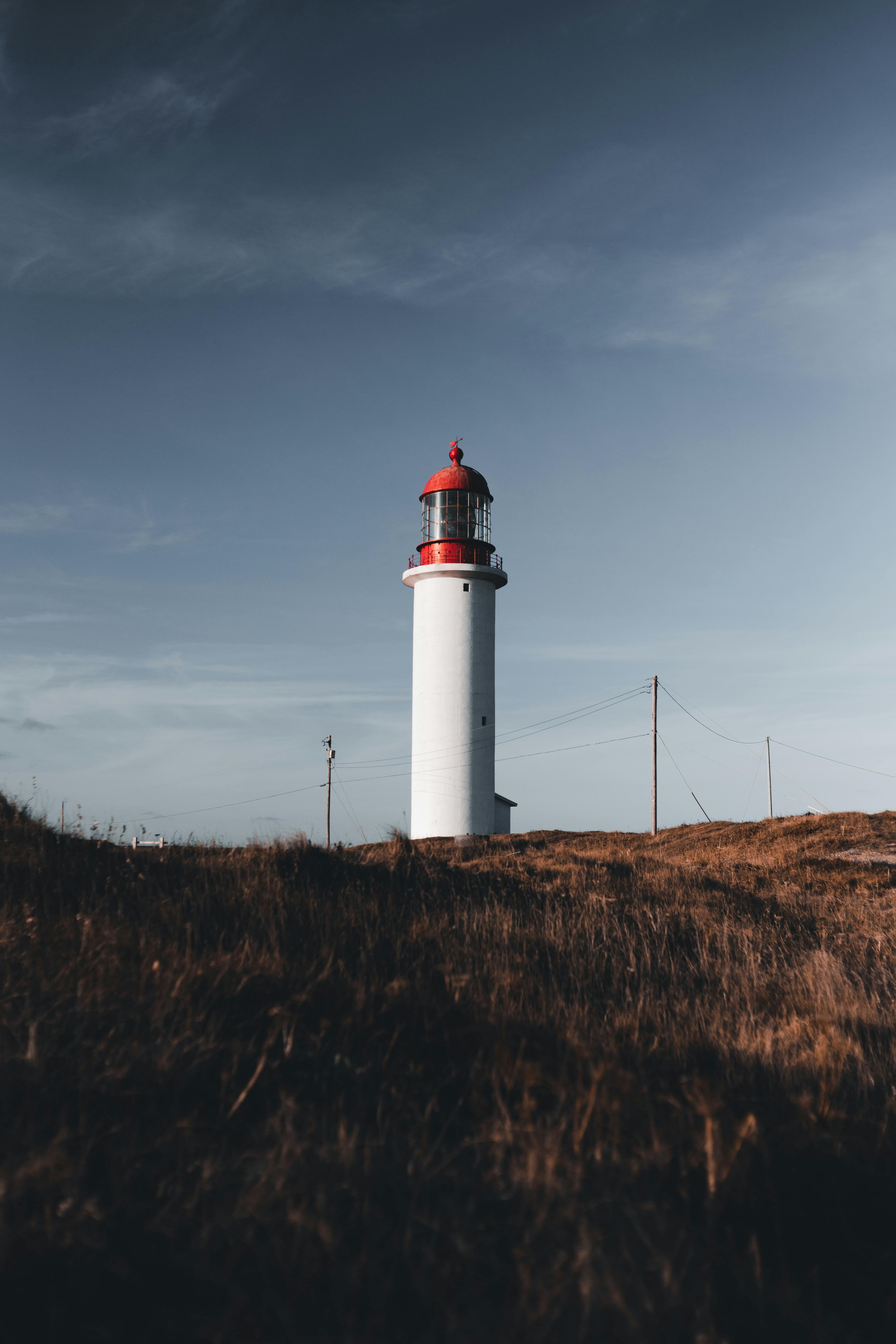 A Lighthouse Standing Tall in the Hill · Free Stock Photo