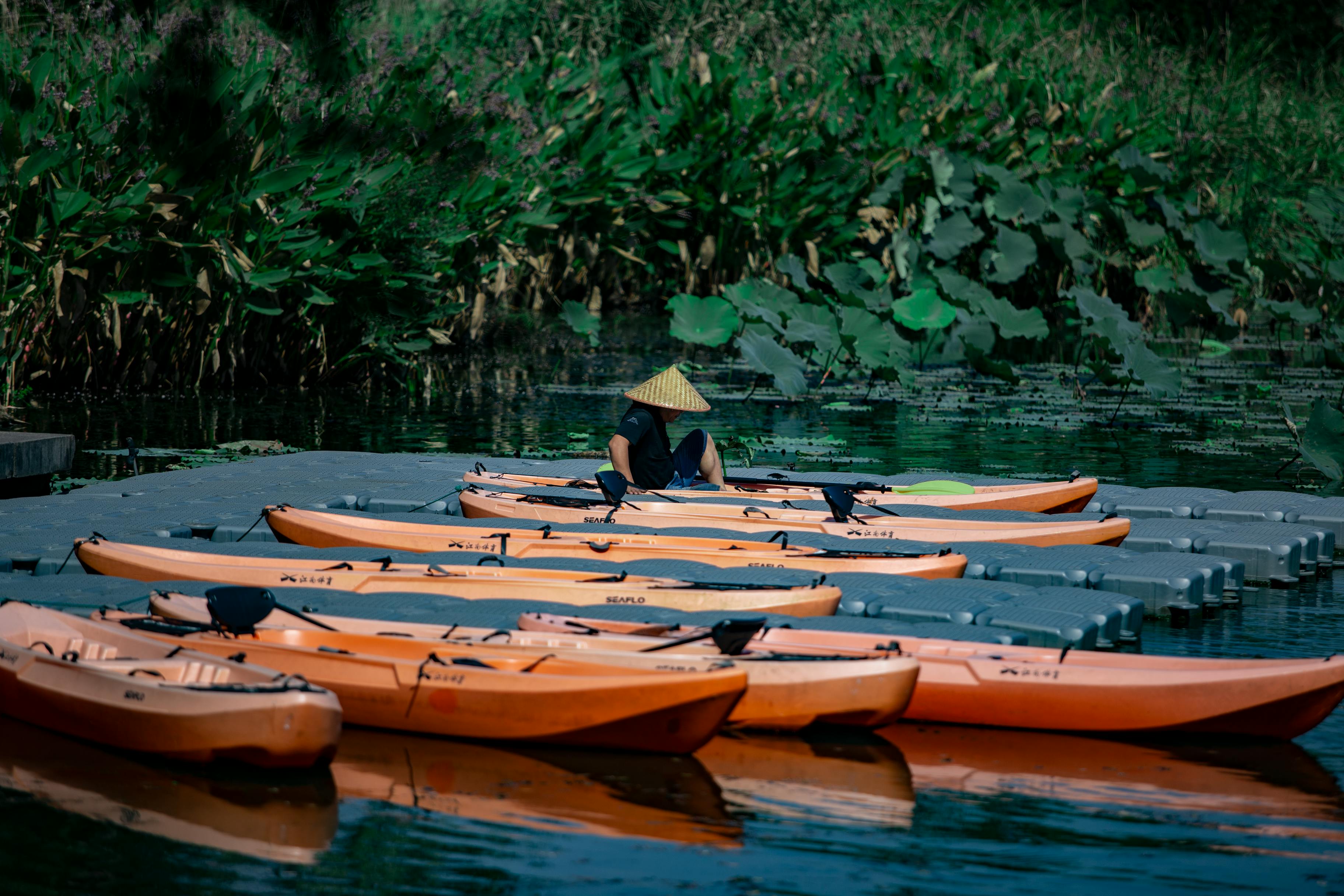 Man Sitting on Orange Kayak · Free Stock Photo