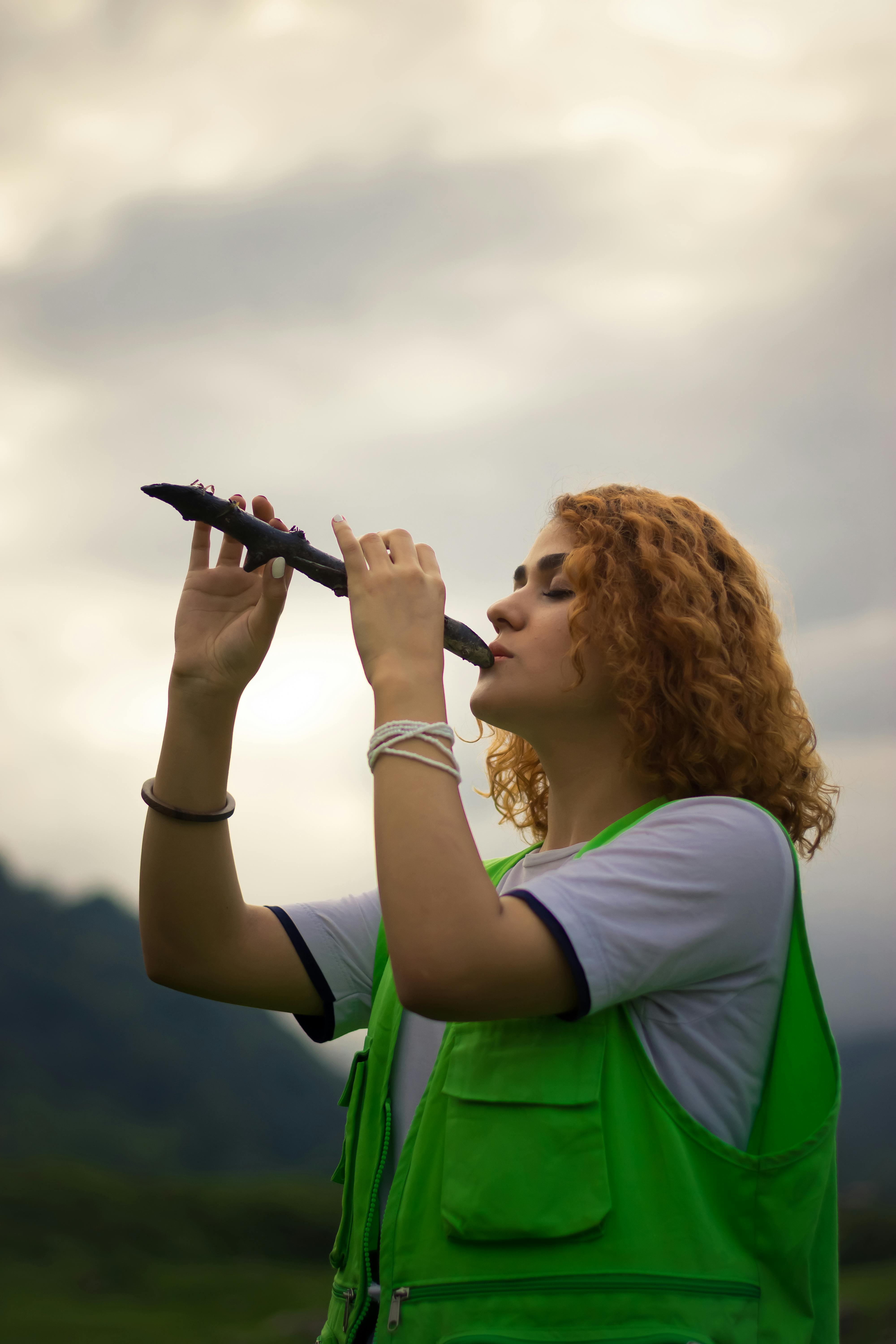 A Woman Crying while Playing Flute · Free Stock Photo