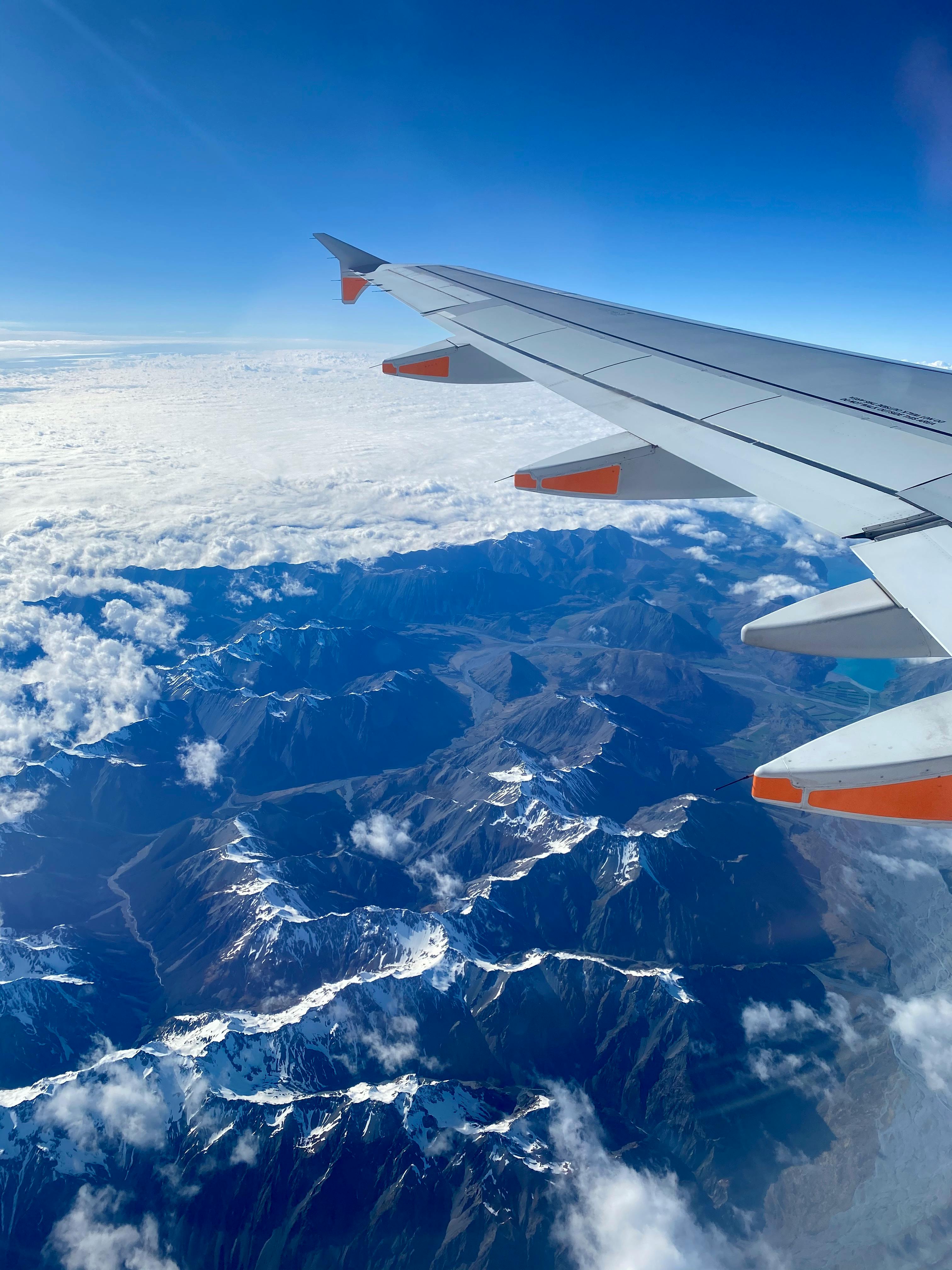 Airplane Flying Over Mountains · Free Stock Photo