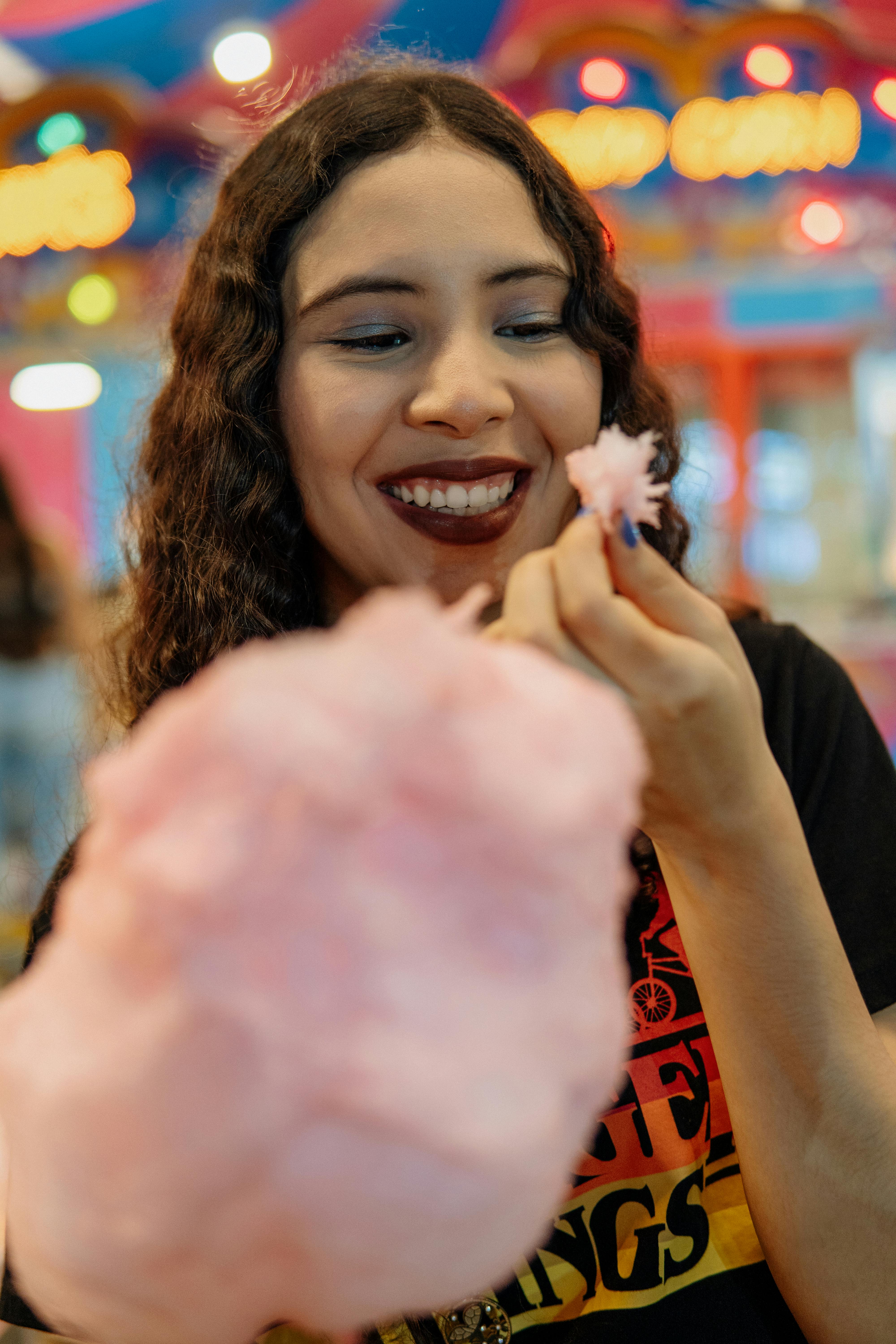 Photo of Woman Eating Cotton Candy · Free Stock Photo