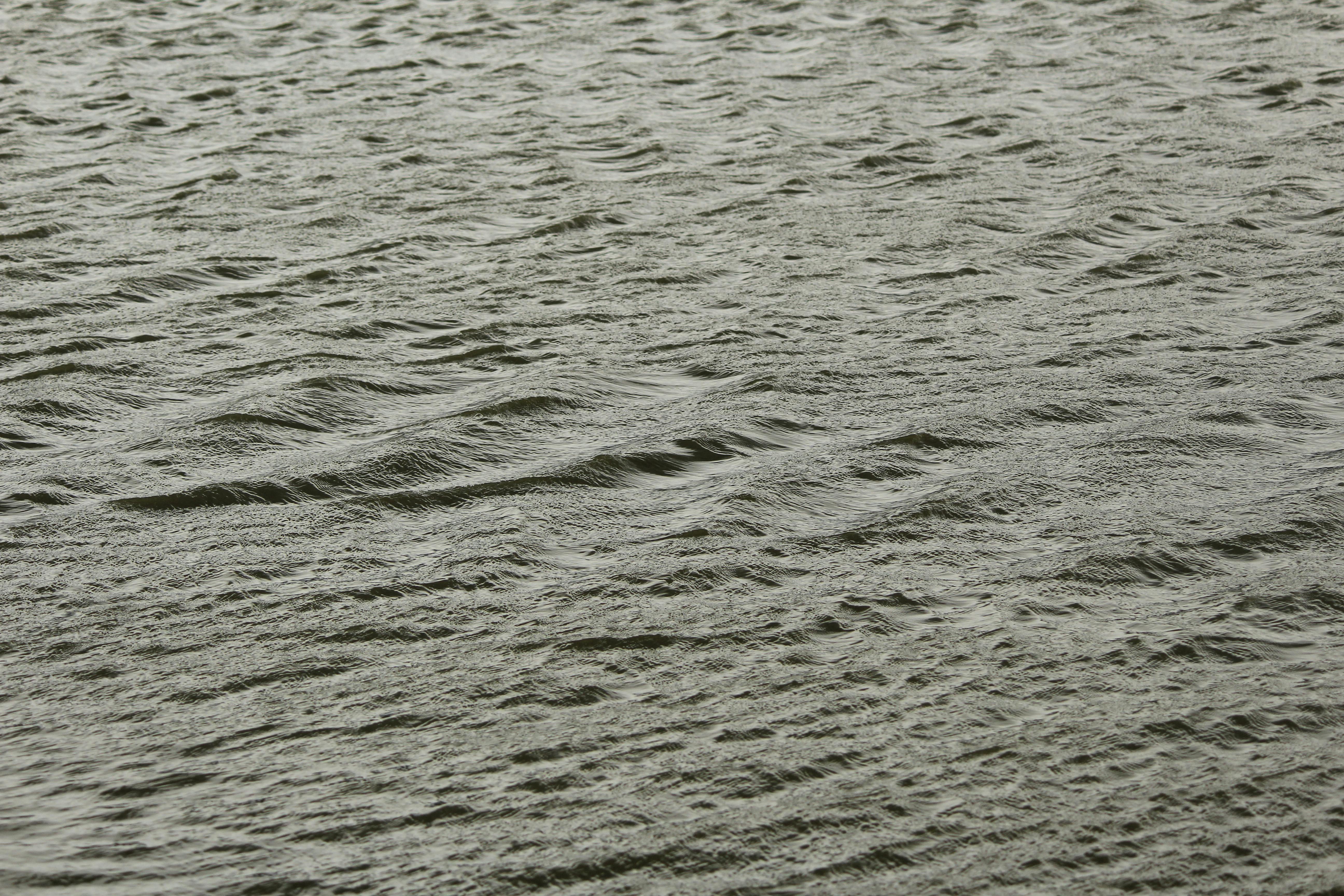 Body of Water Between Brown Land · Free Stock Photo