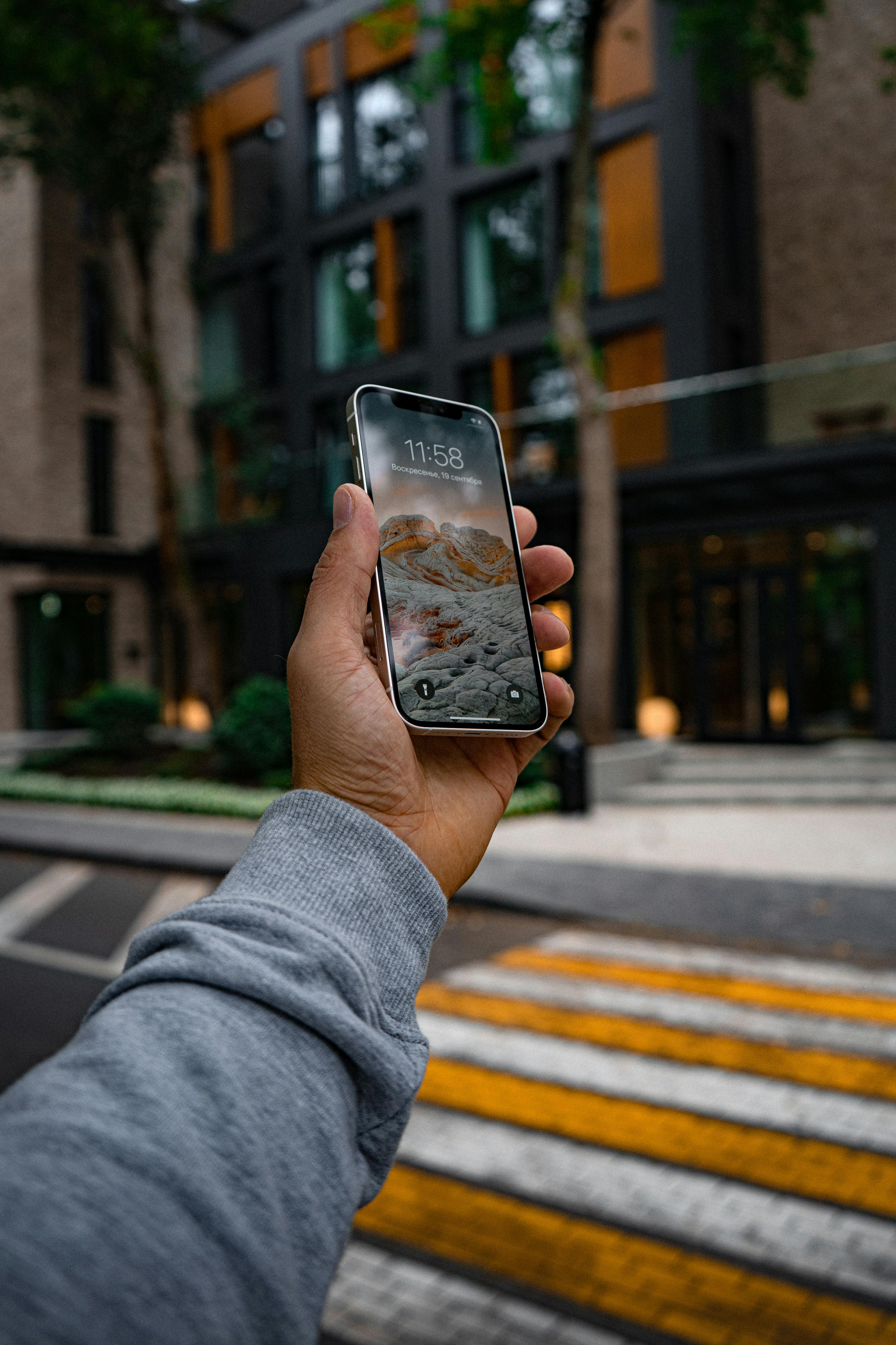 A Hand Holding an Iphone · Free Stock Photo