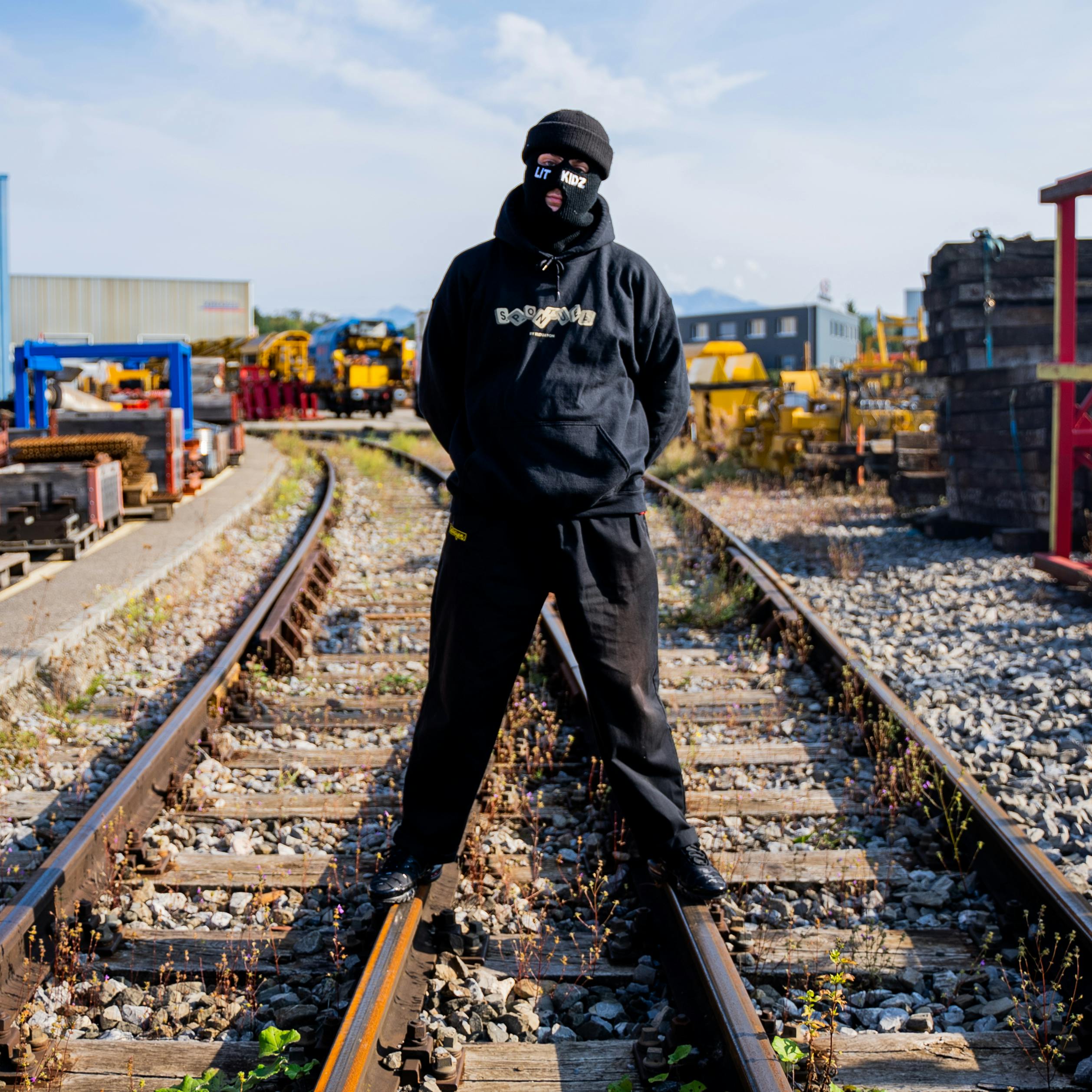 Man in Black Jacket Standing on Train Tracks · Free Stock Photo