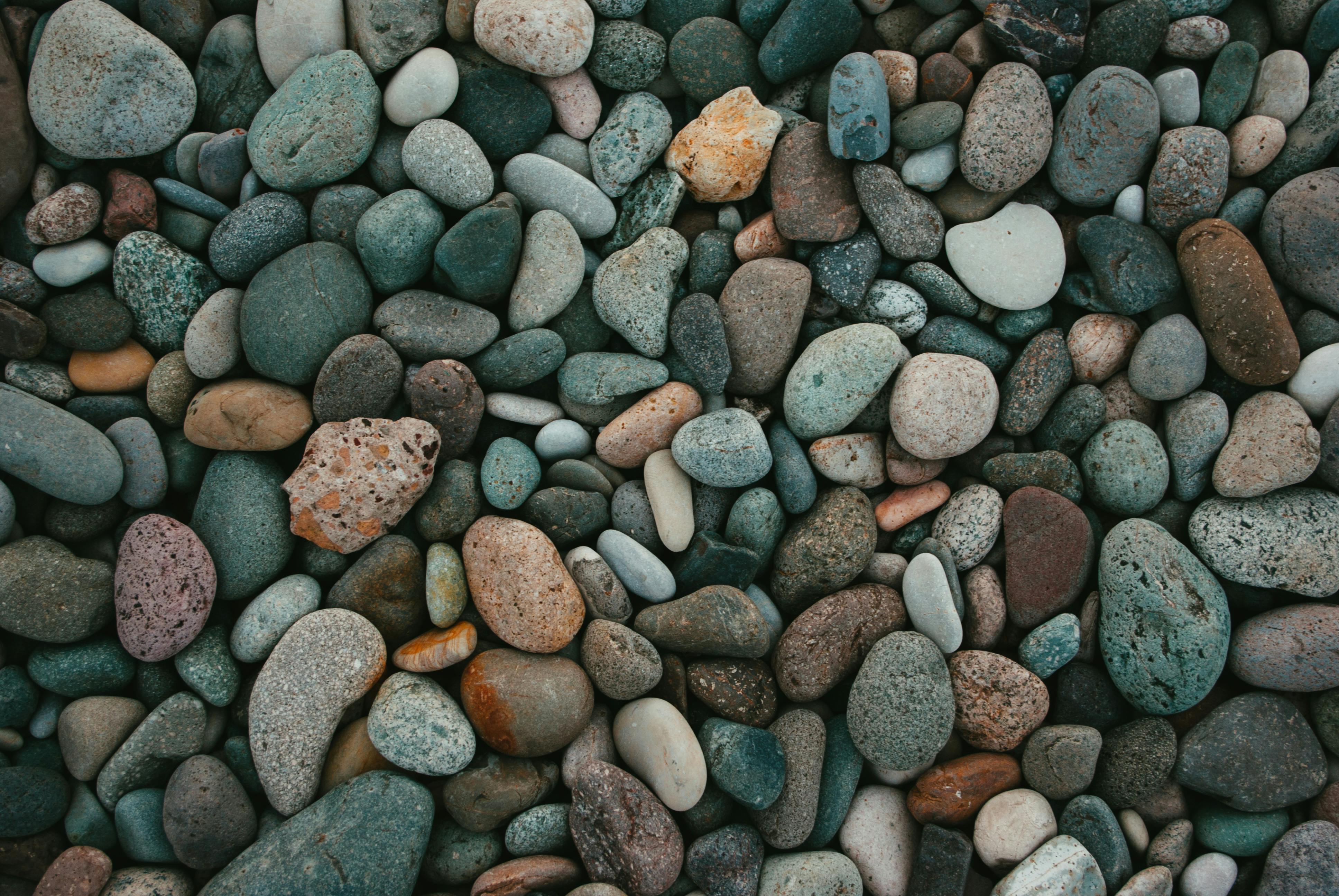 Row of Black and Gray Polished Pebble on Gray Surface · Free Stock Photo