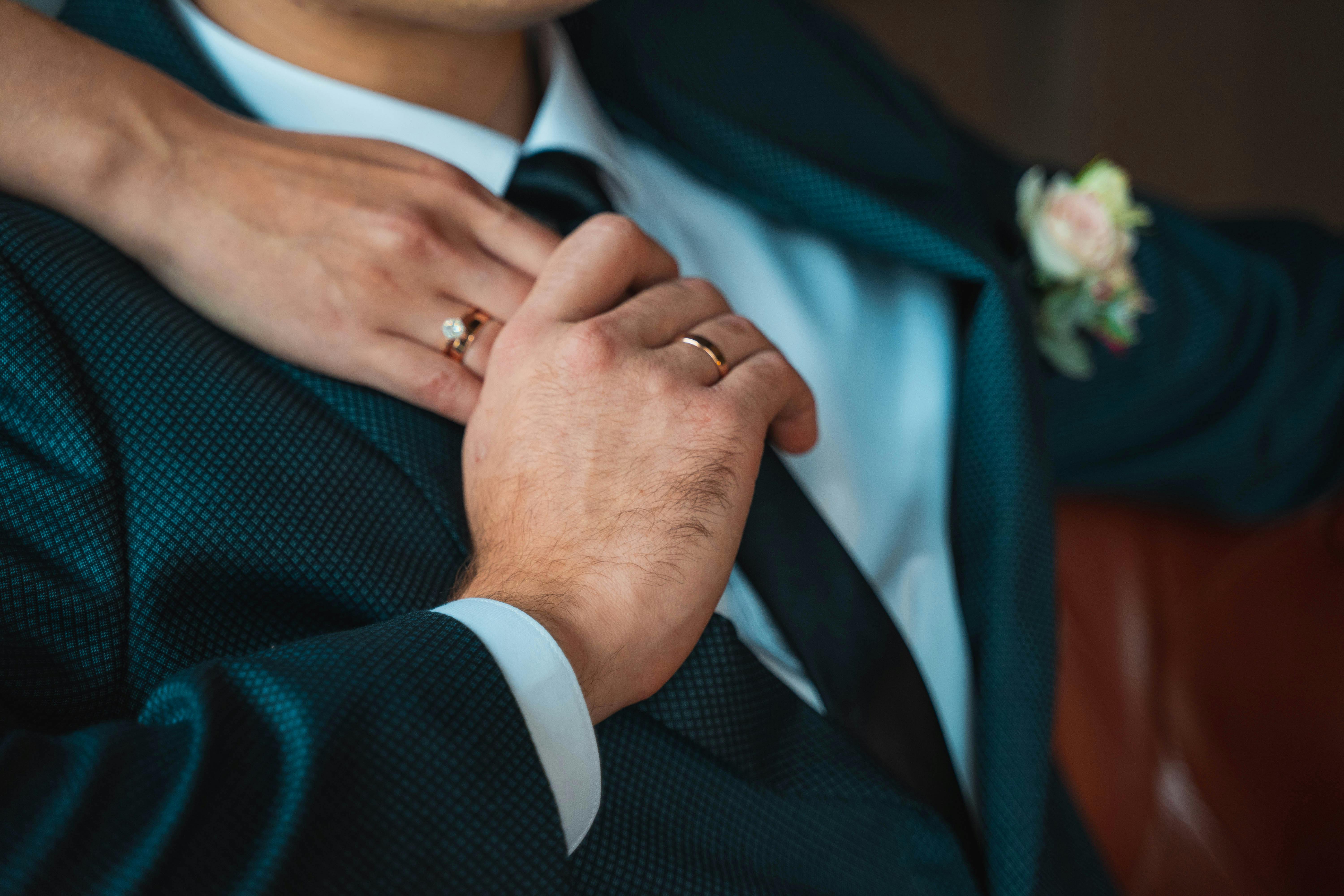 Close-up of Groom Touching Bow · Free Stock Photo